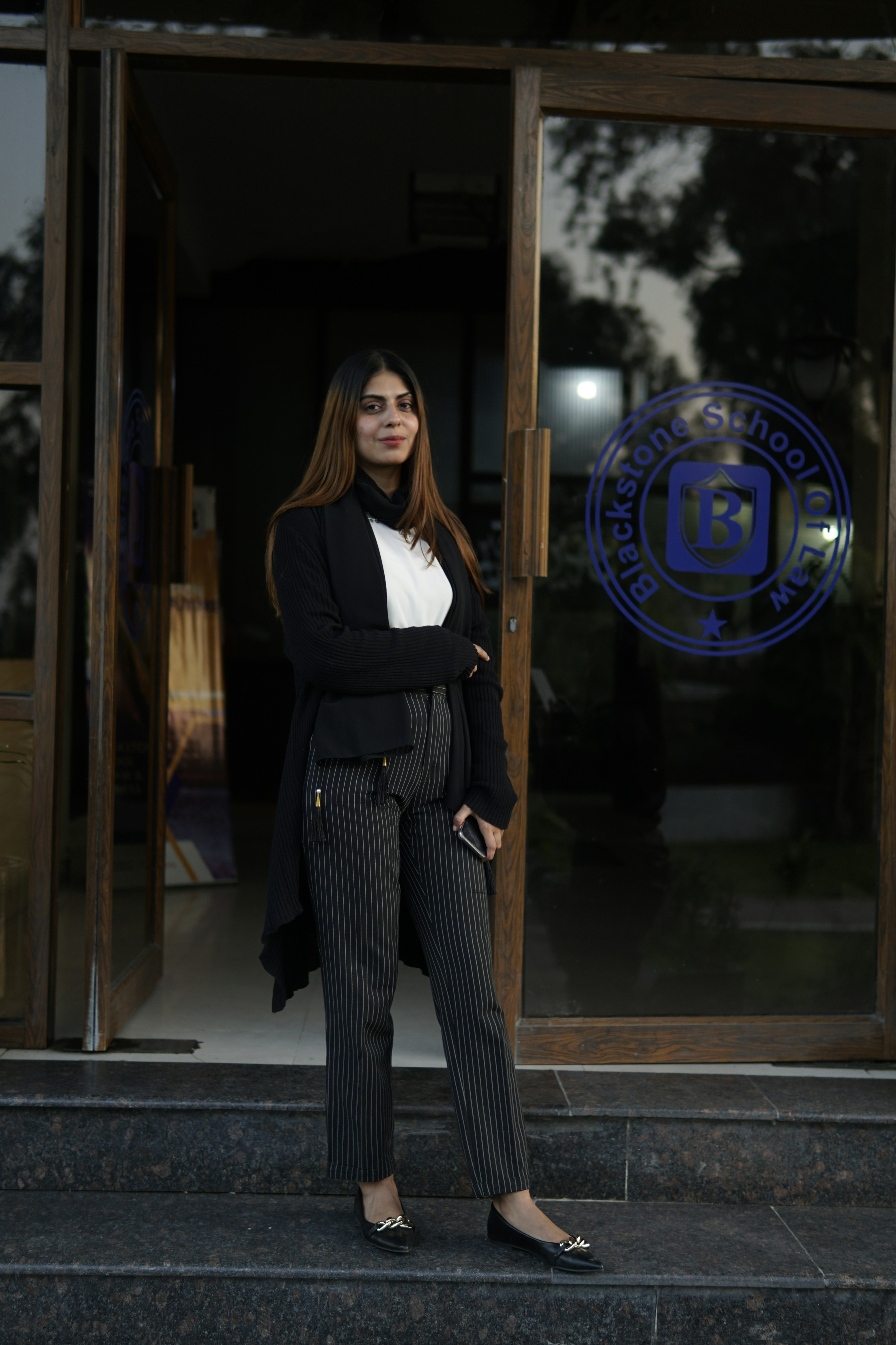 Portrait at the Entrance: Confidence by the Glass Door