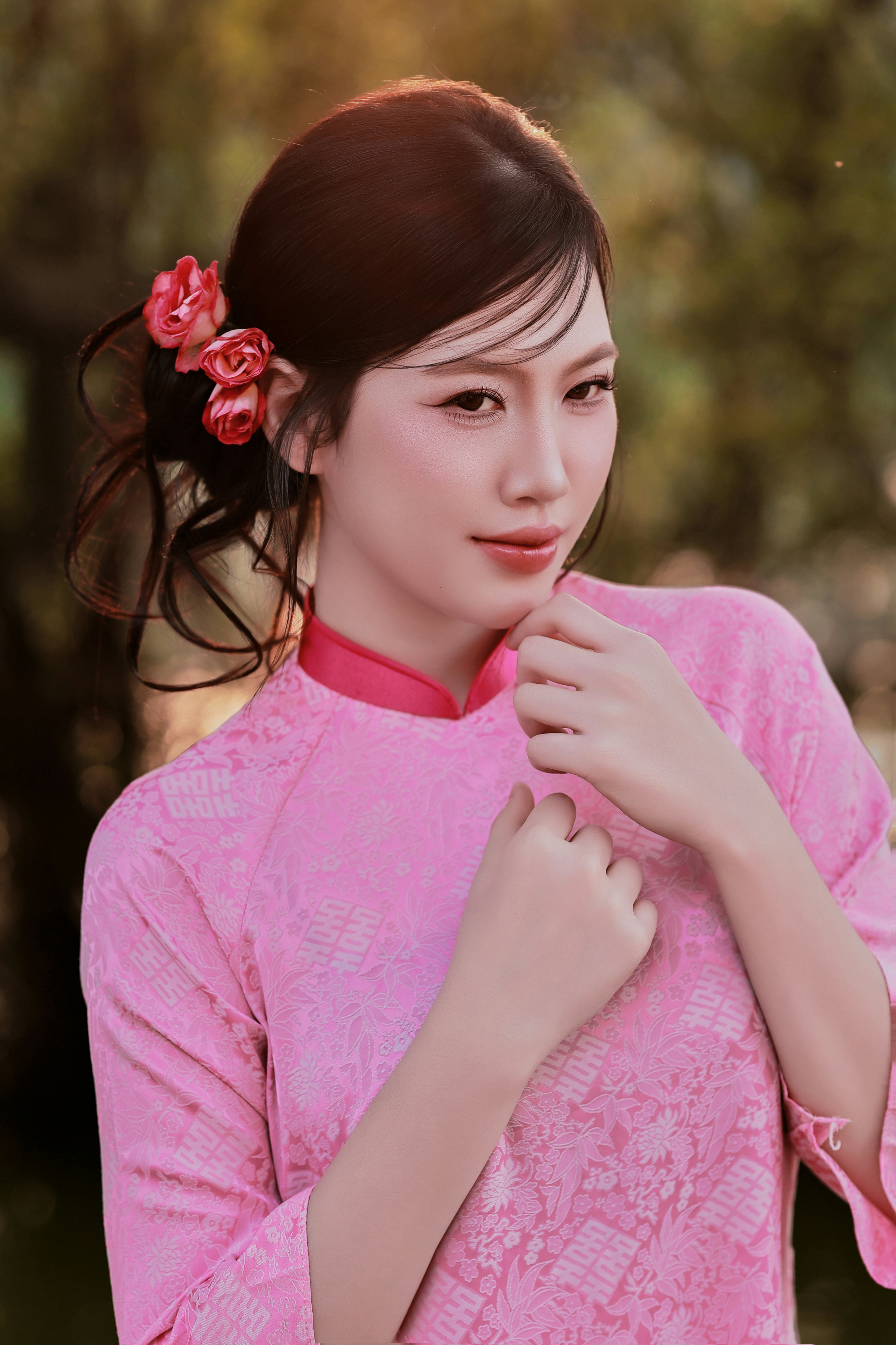 Beautiful Vietnamese girl in traditional Vietnamese dress on Tet holiday by Hoan Kiem Lake
