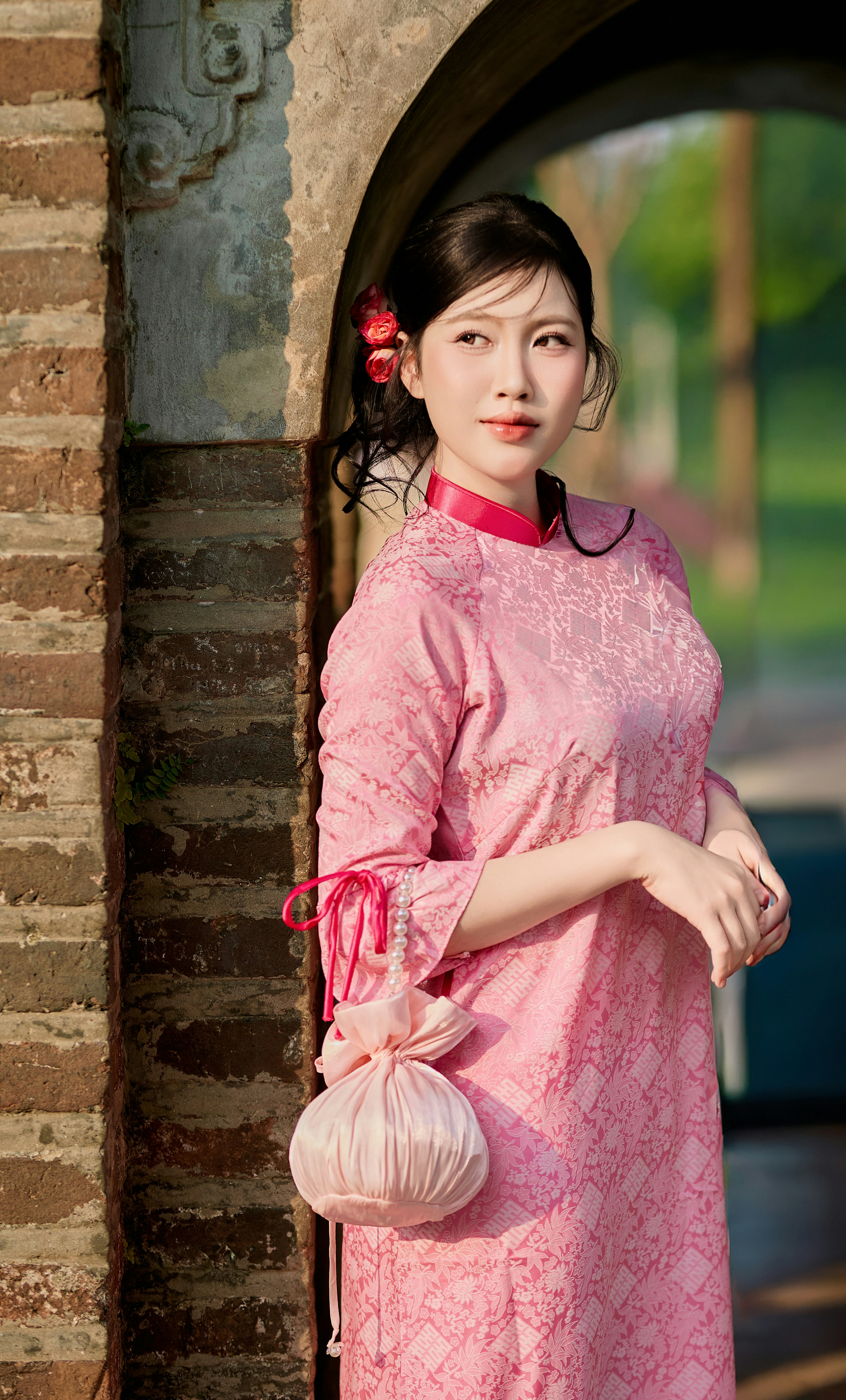 Beautiful Vietnamese girl in traditional Vietnamese dress on Tet holiday by Hoan Kiem Lake