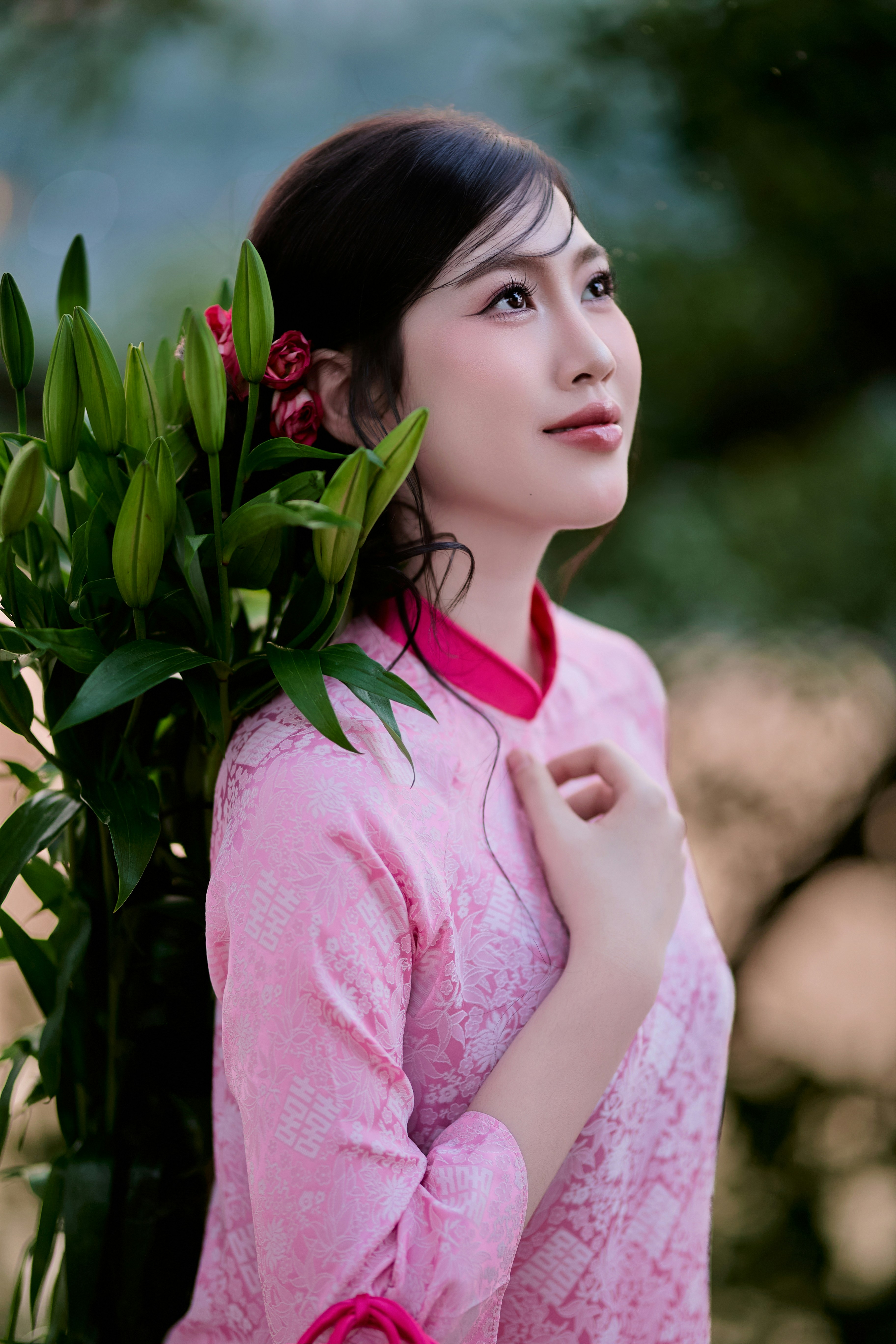 Beautiful Vietnamese girl in traditional Vietnamese dress on Tet holiday by Hoan Kiem Lake