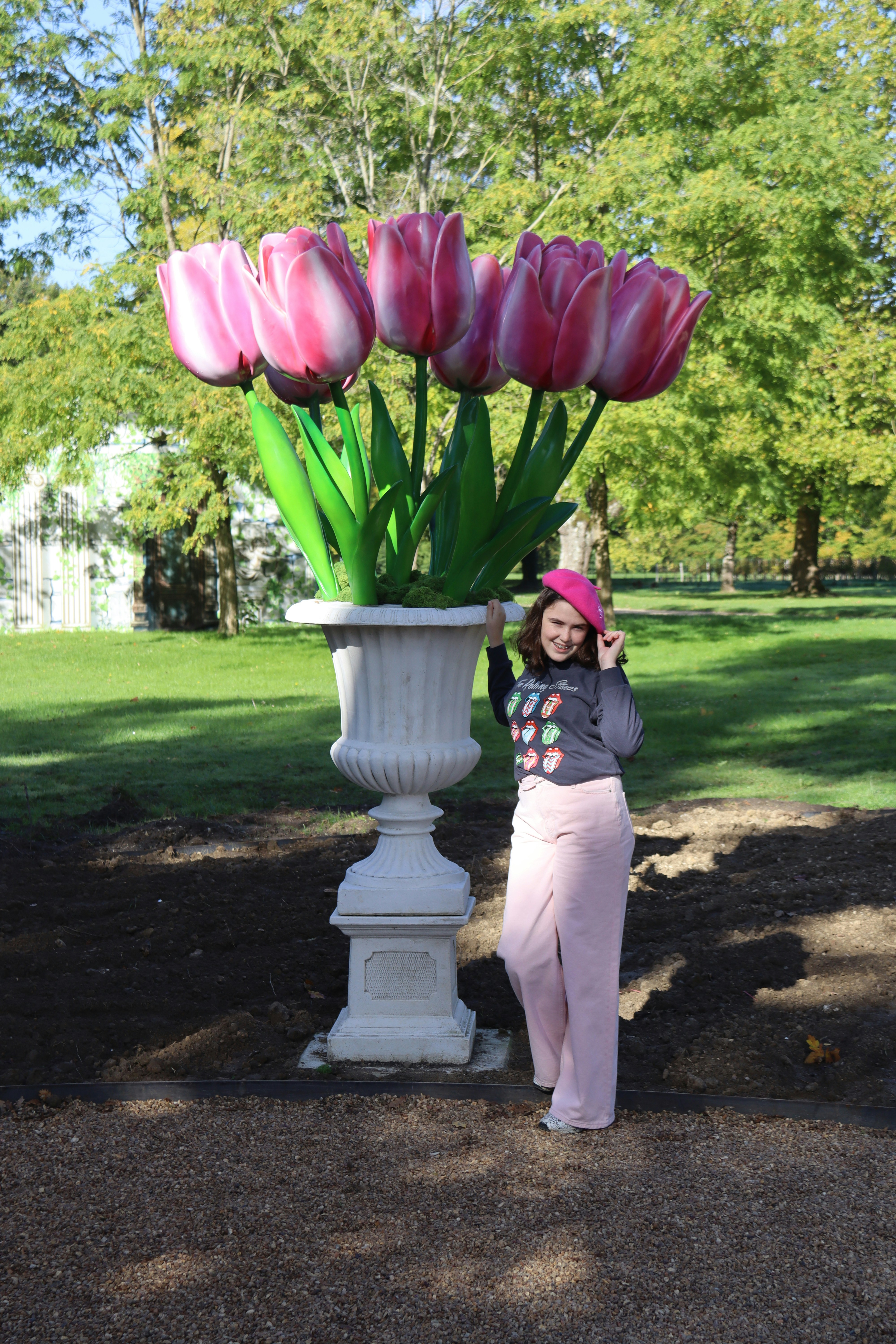 Tulips in Bloom: A Girl and a Garden Sculpture