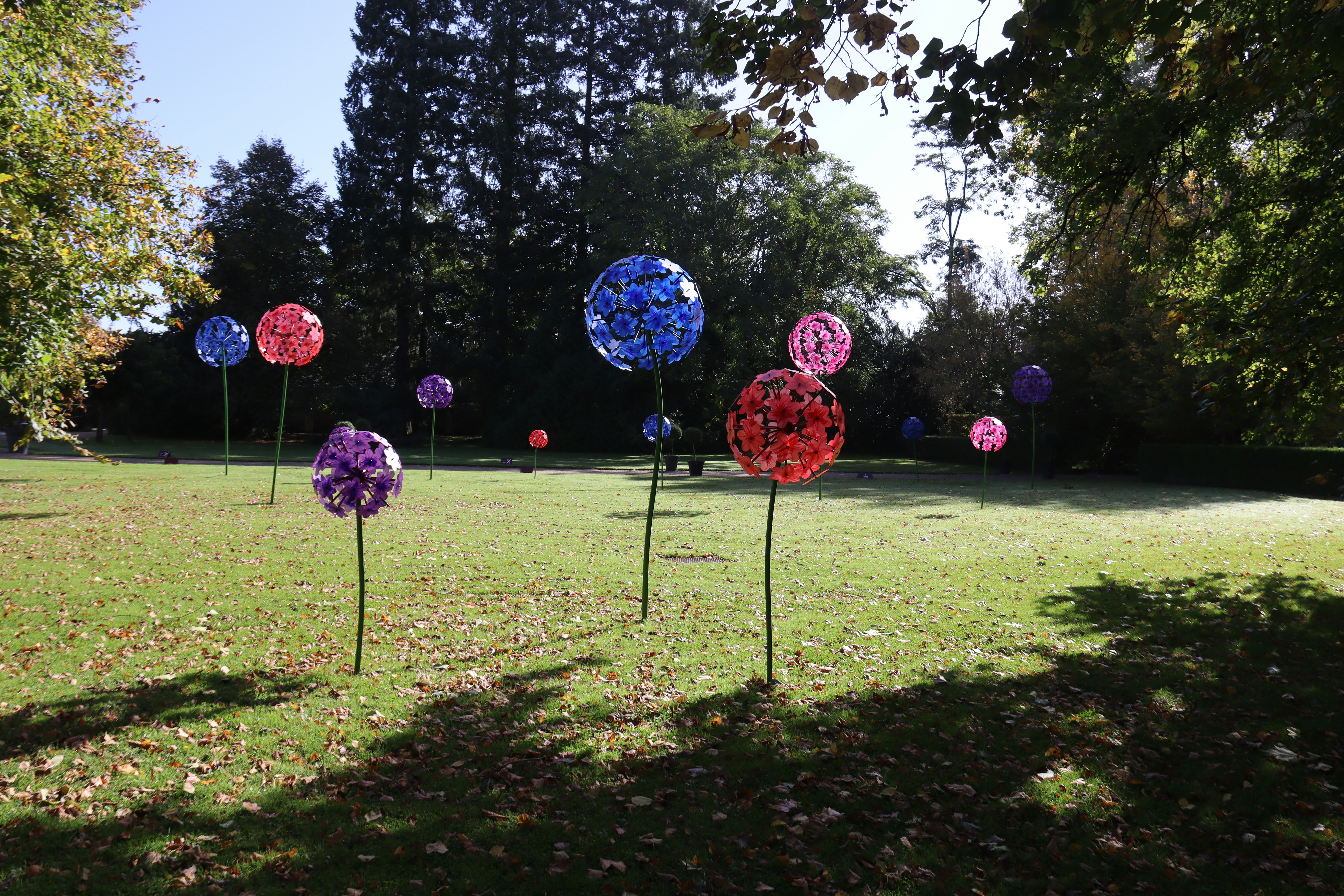 Bubble-Globe Garden: Colorful Orbs on Stems in Sunlit Park