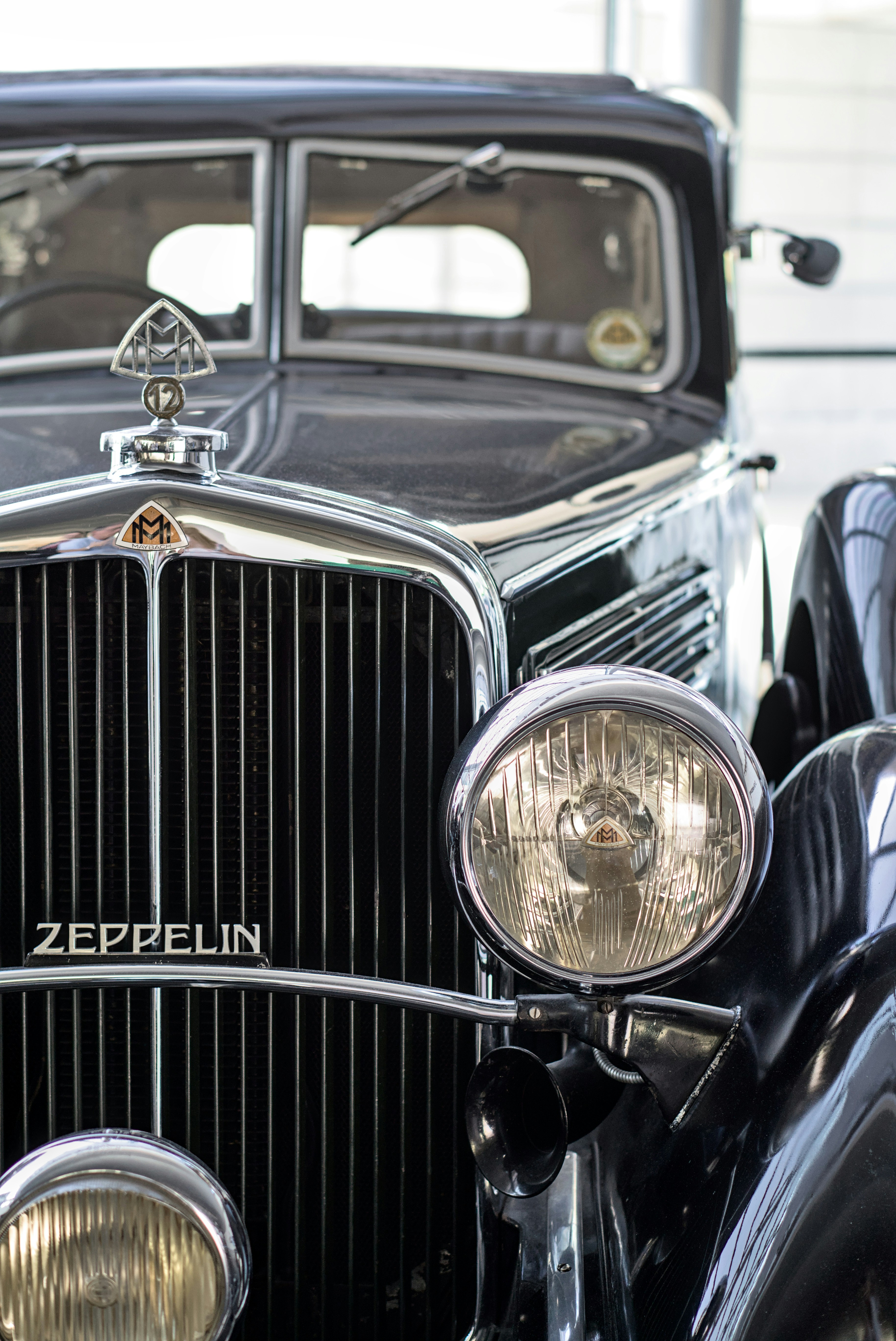 Grayscale Majesty: The Zeppelin Emblem and Gleaming Grille of a Vintage Classic
