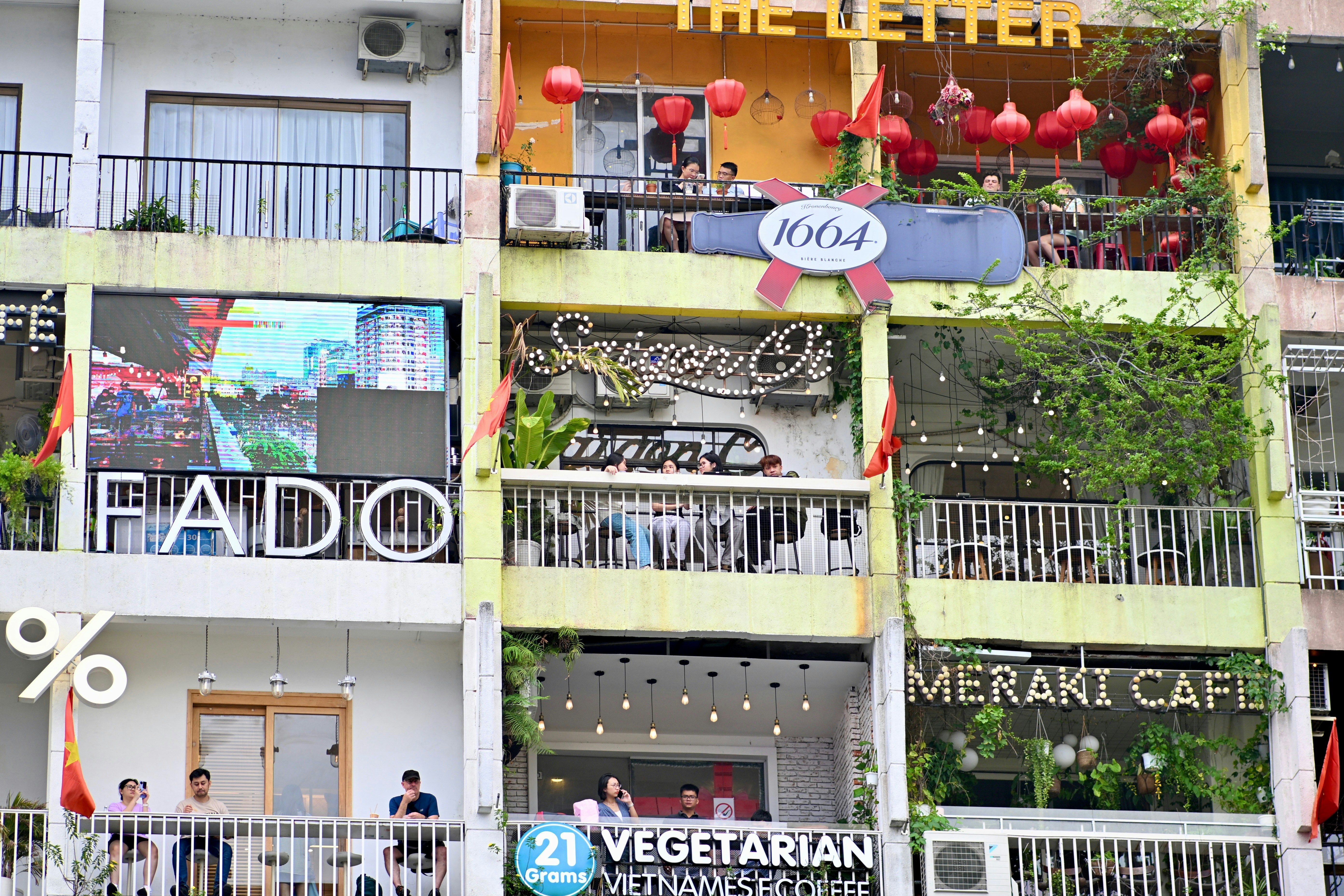 Lantern-lit Balcony Over Hanoi: A Multi-Storey Café Scene