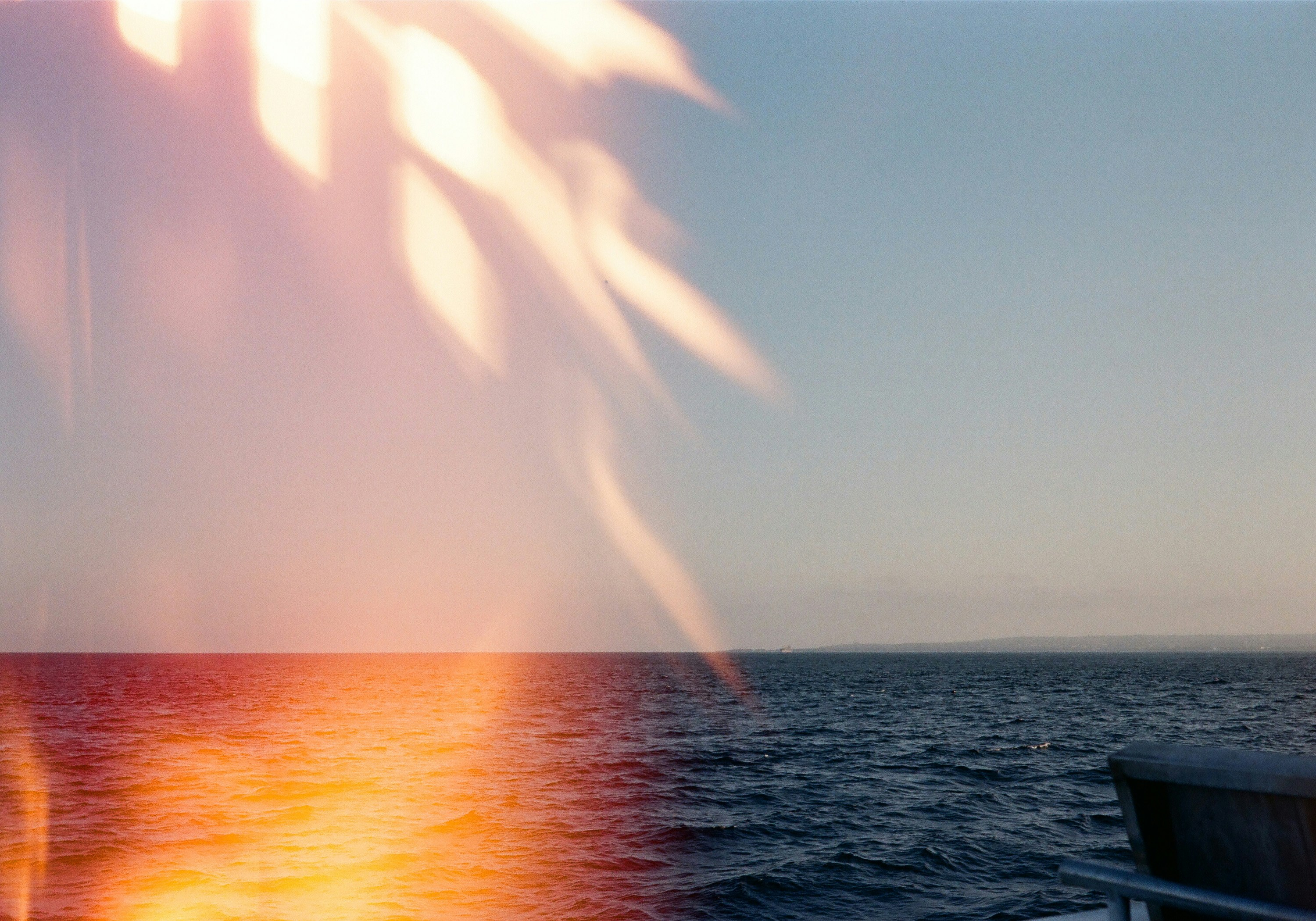 Ocean view with light flares and distant land. photo – Free Sea Image ...