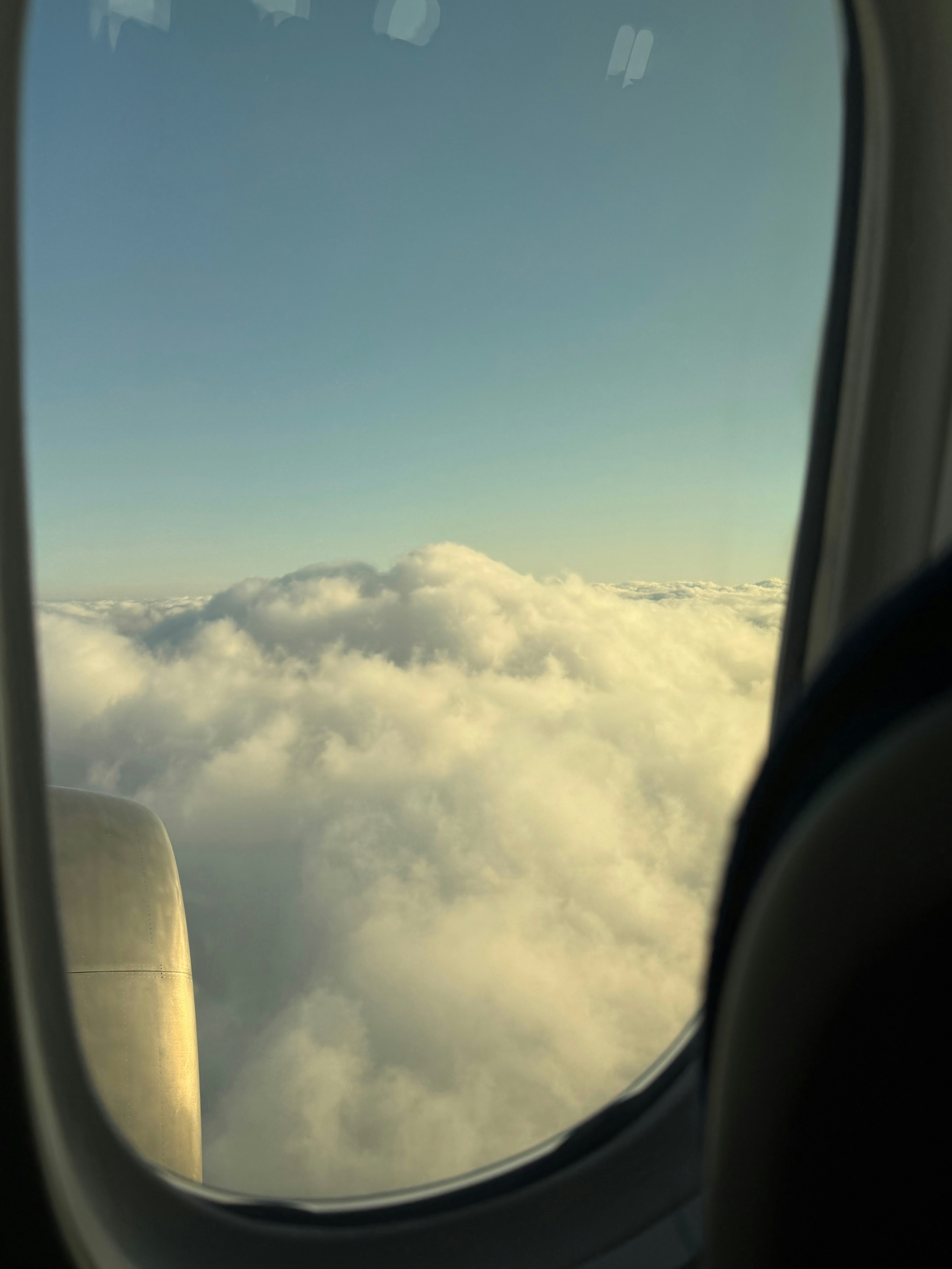 Above the Clouds: Window View from a Quiet Altitude