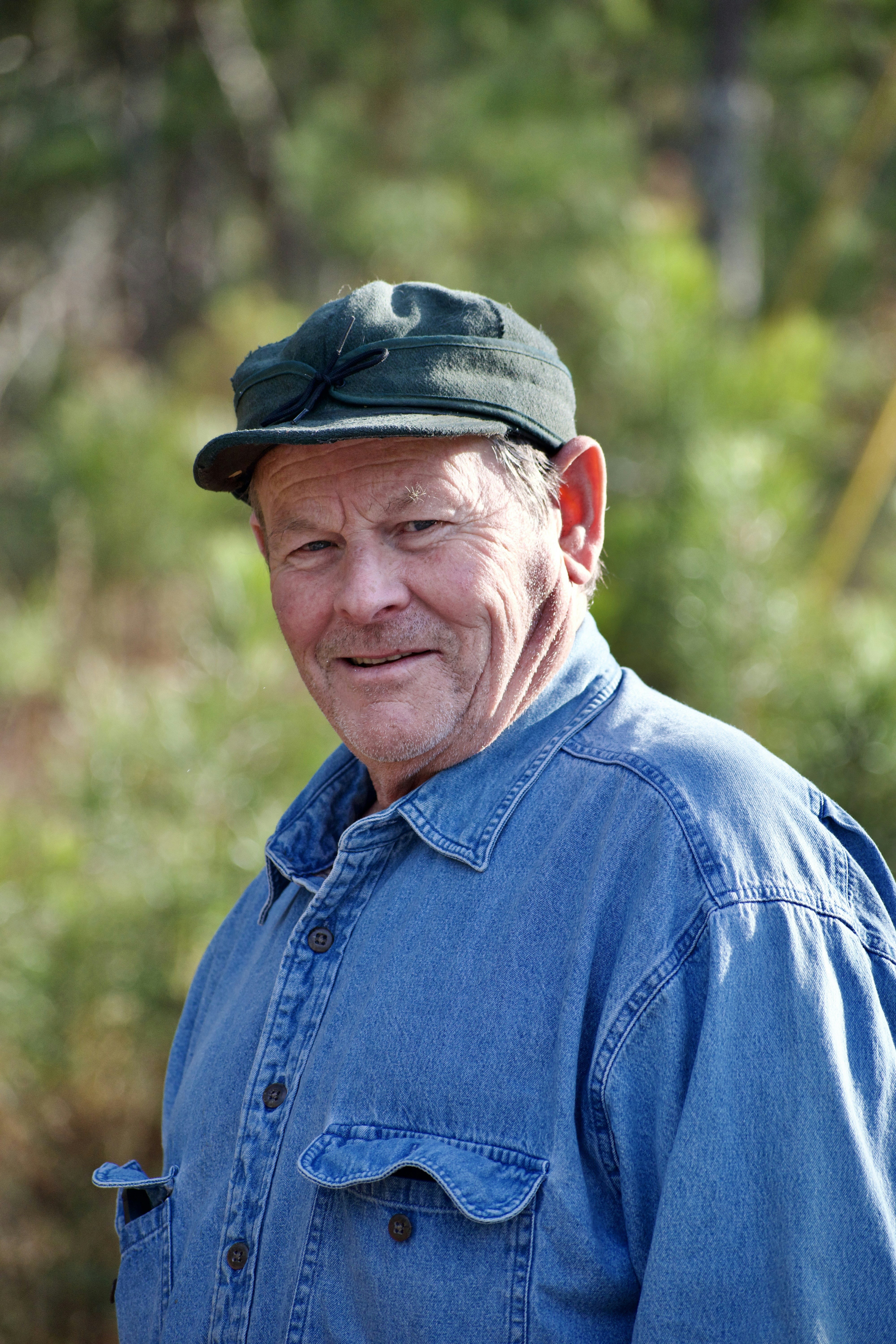 Portrait of a Weathered Craftsman in a Denim Shirt