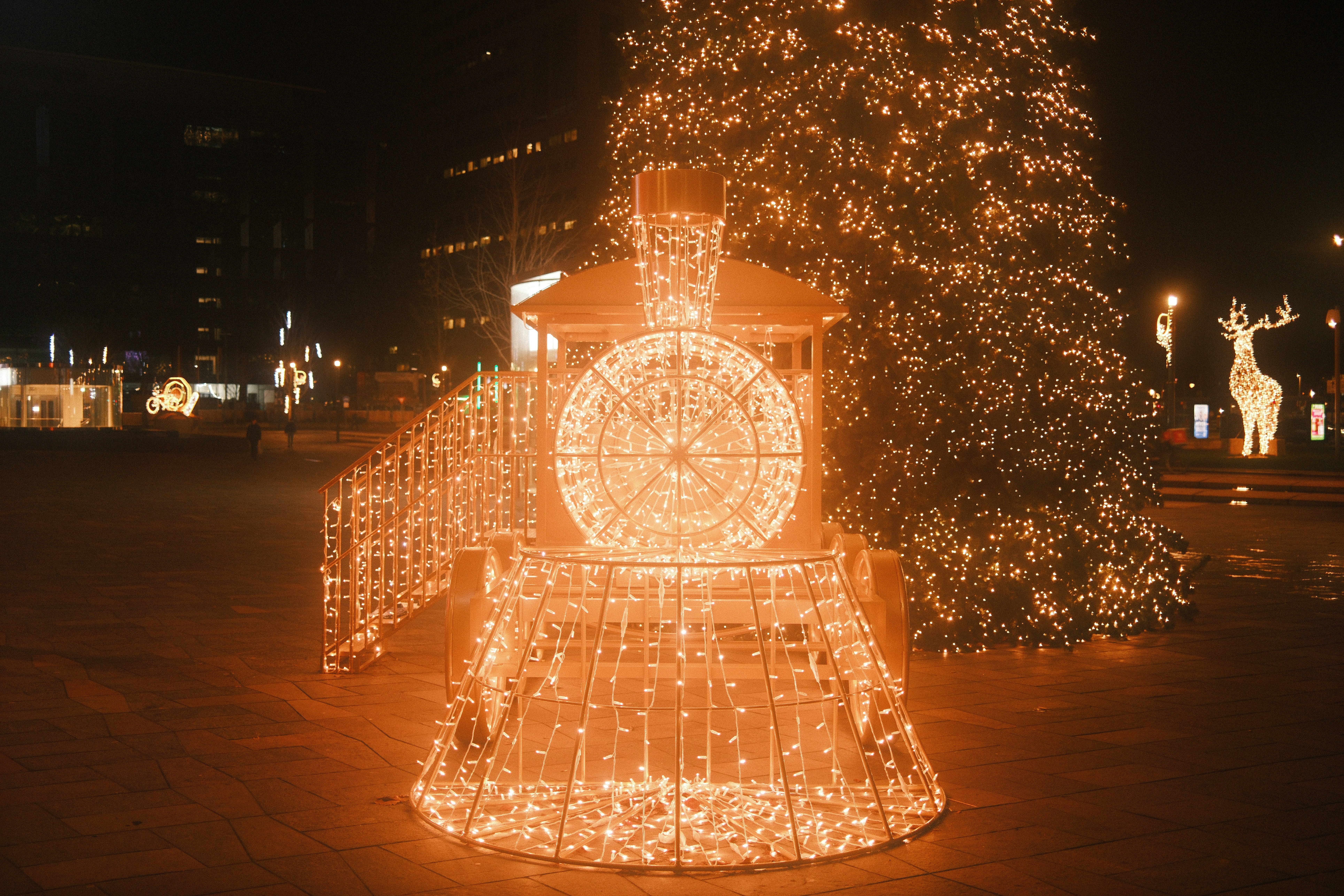 Glowing Ferris-wheel Illumination in a Night Plaza