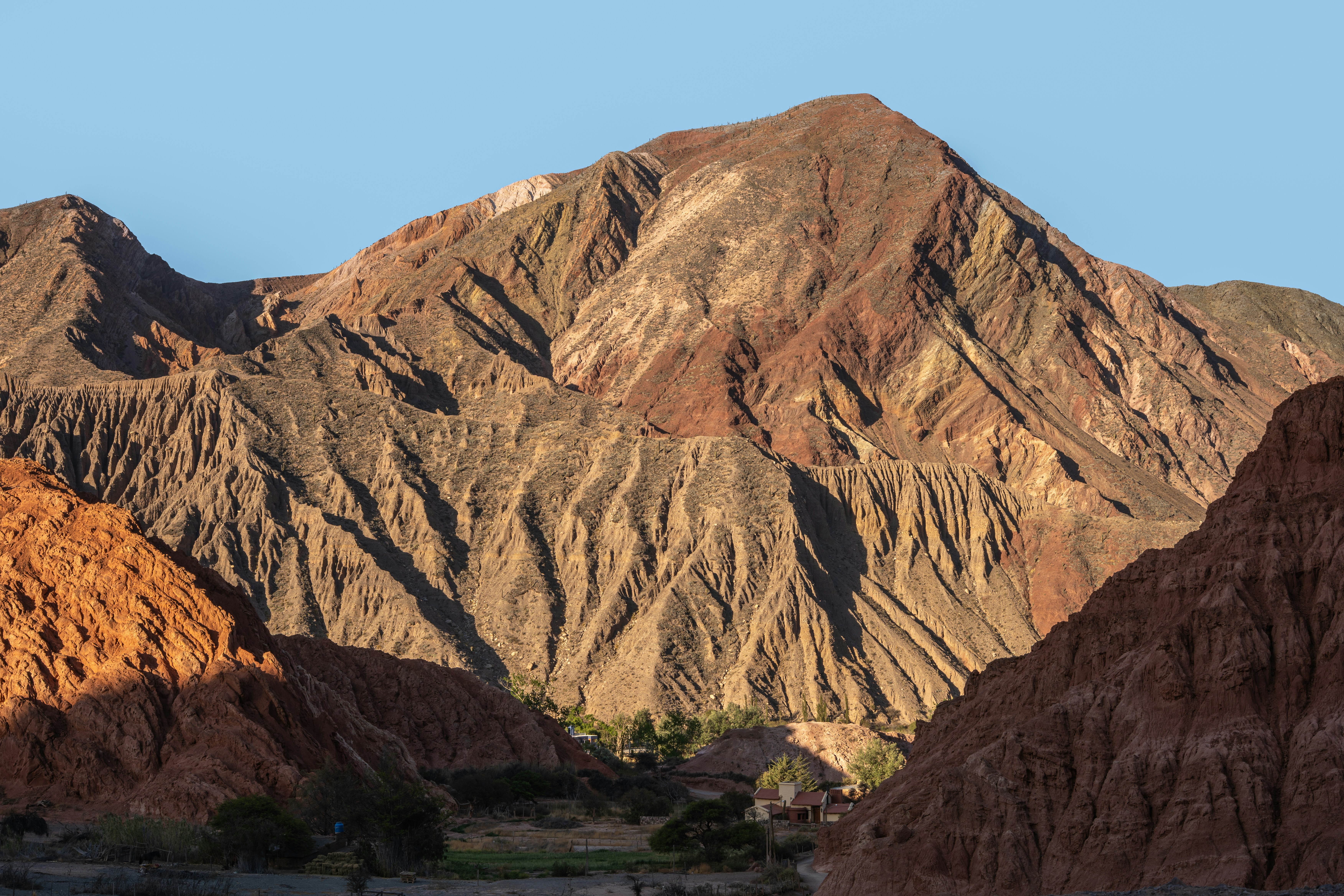 Narrow rock passage in Humahuaca showing canyon-like formations and soft warm light on the walls.