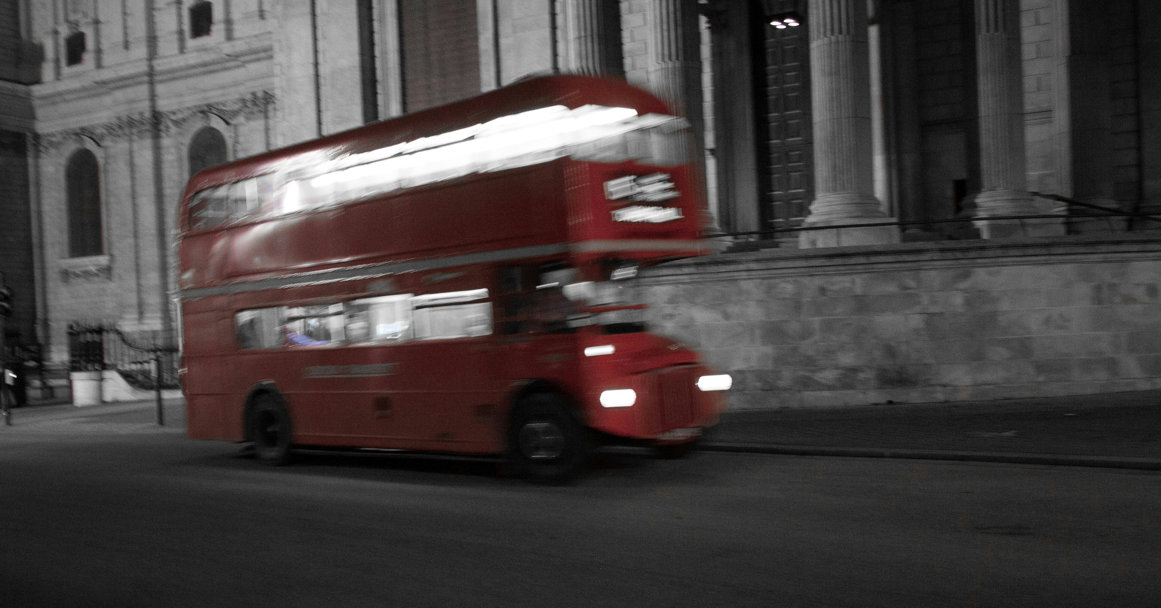 A red double-decker bus driving on a street. photo – Free Travel Image ...