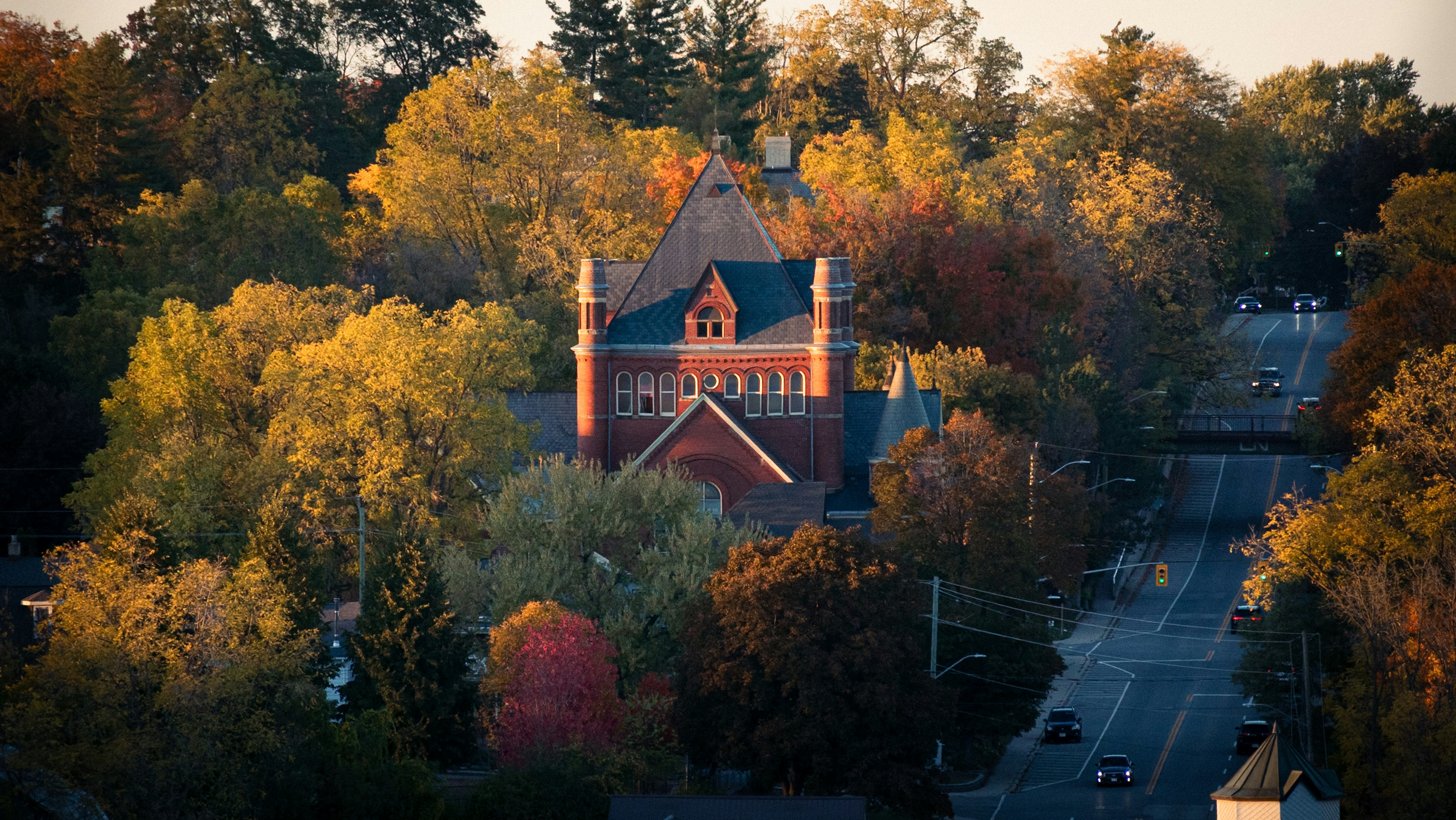 Brick building surrounded by autumn trees and road. photo – Free ...