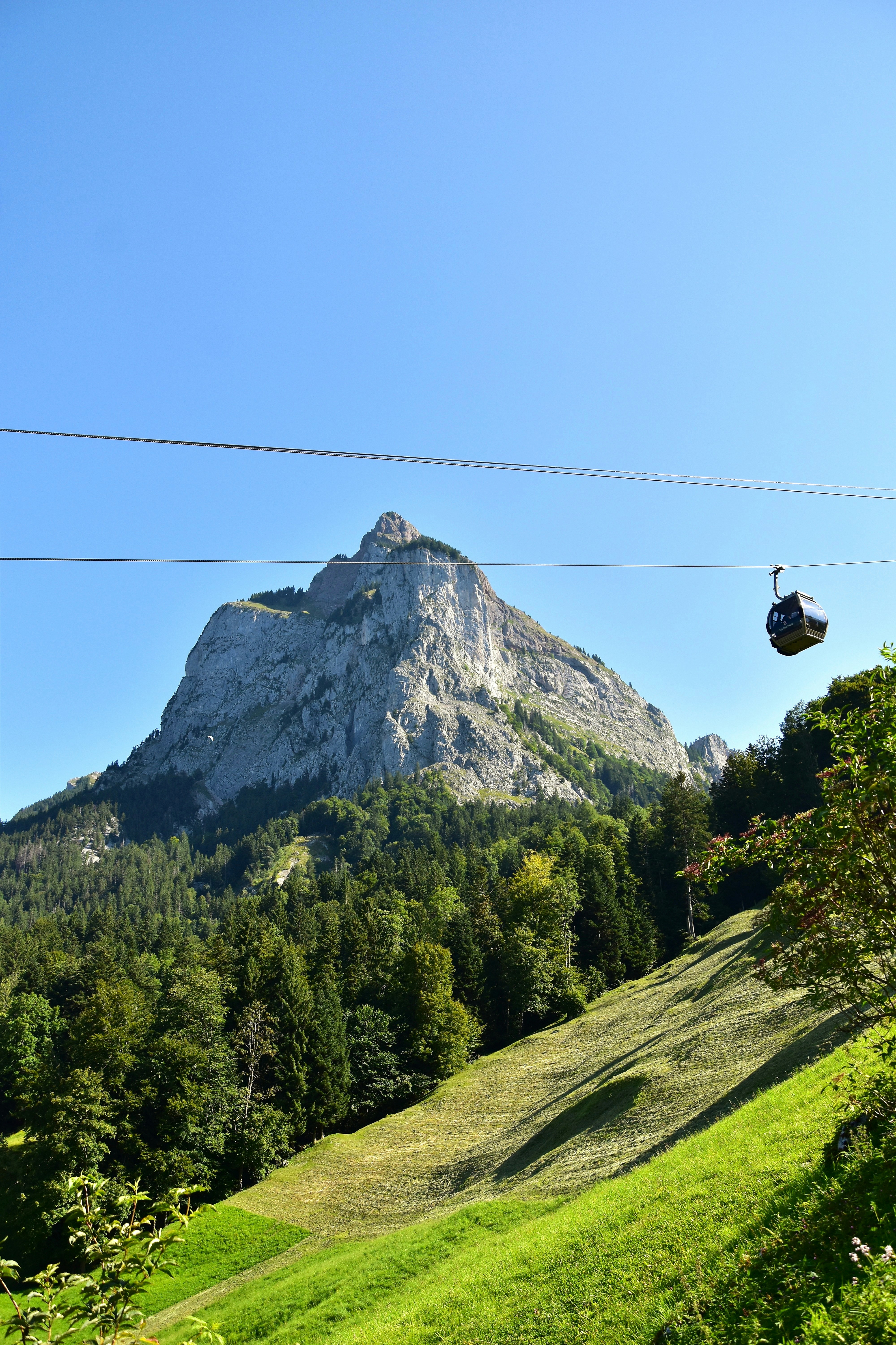Cable Car Ascent to a Jagged Peak