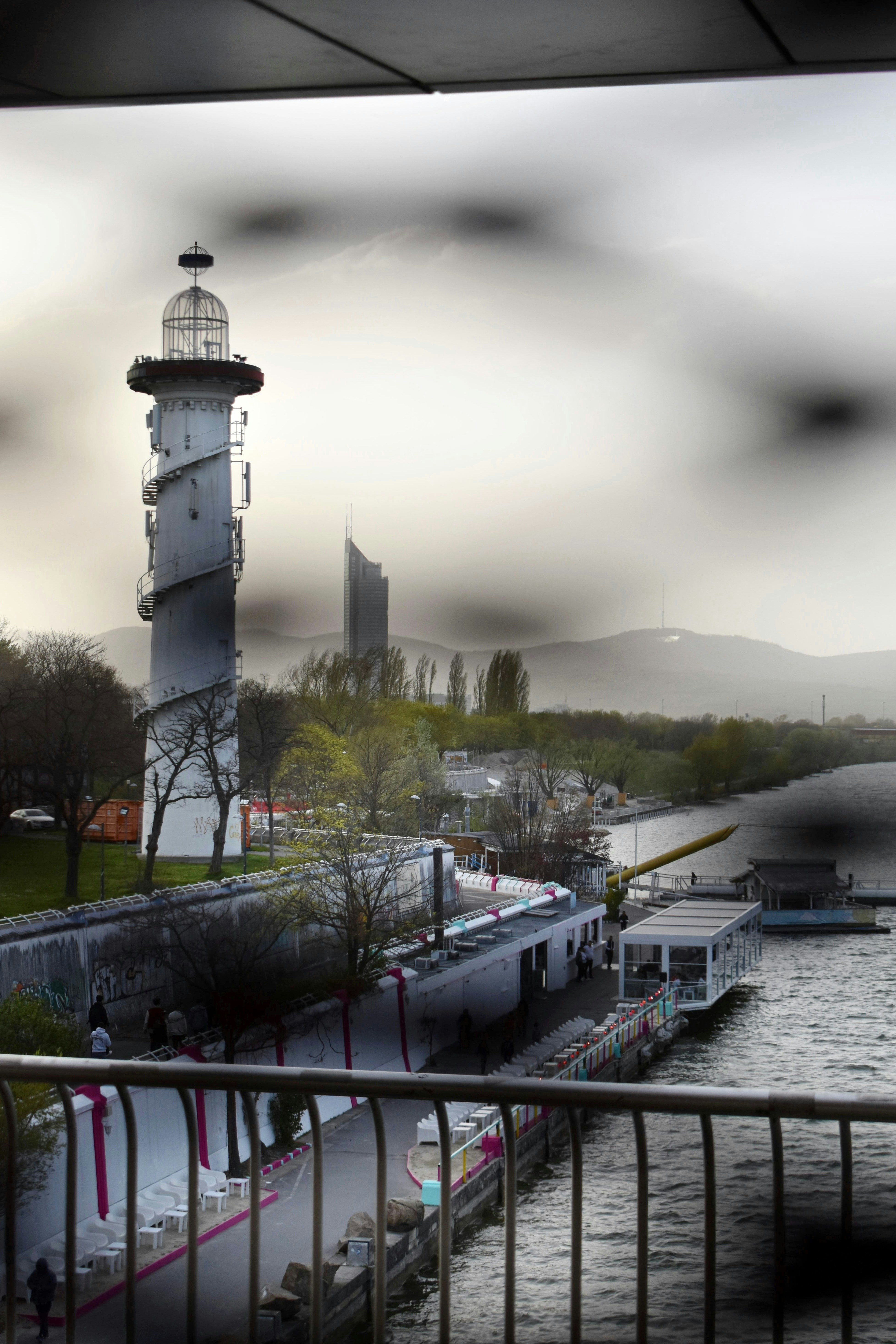 Lighthouse Overcast: A Quiet Harbor Framed by a Looming Mist