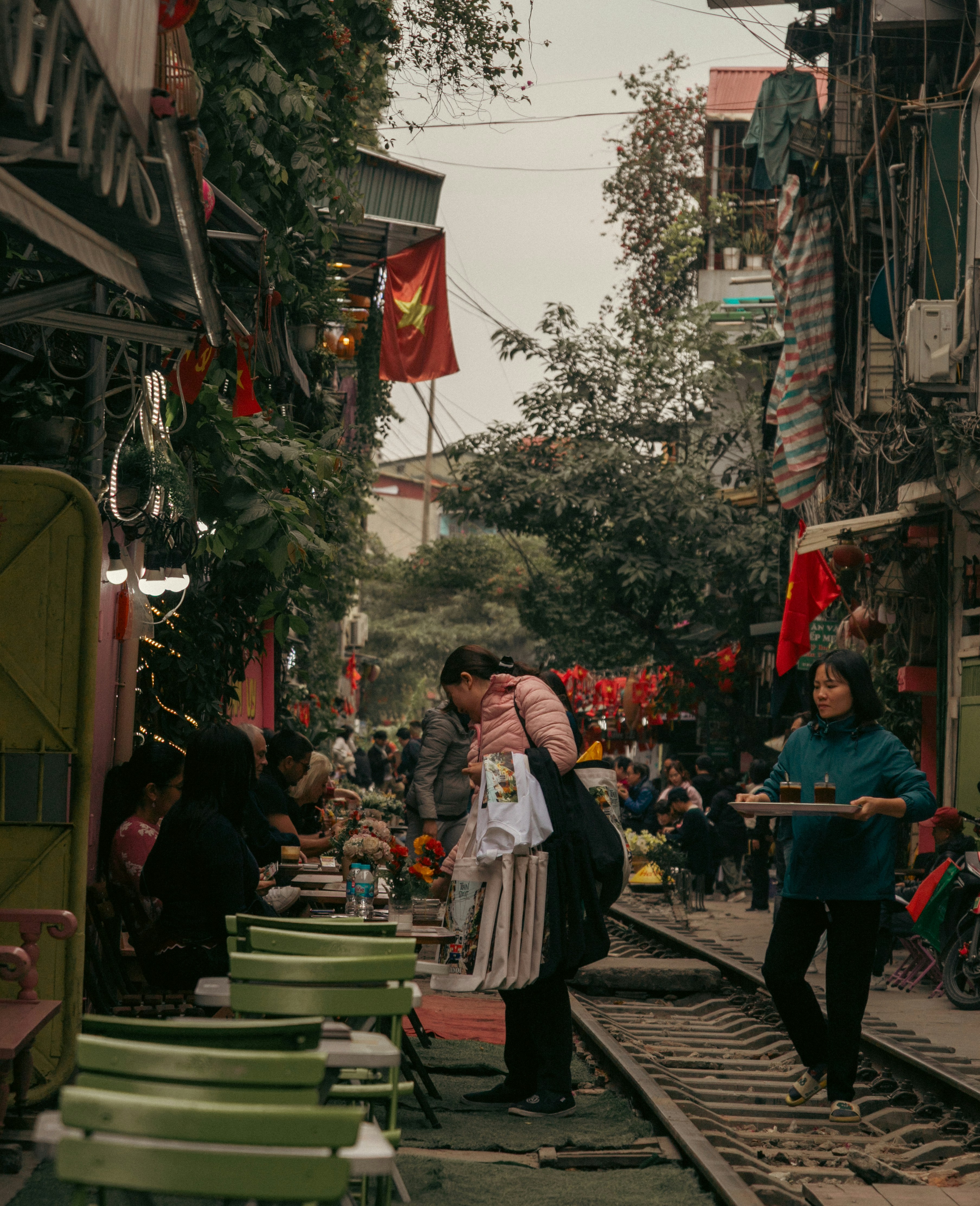 Railway-Front Café: A Bustling Street scene framed by tracks and red banners