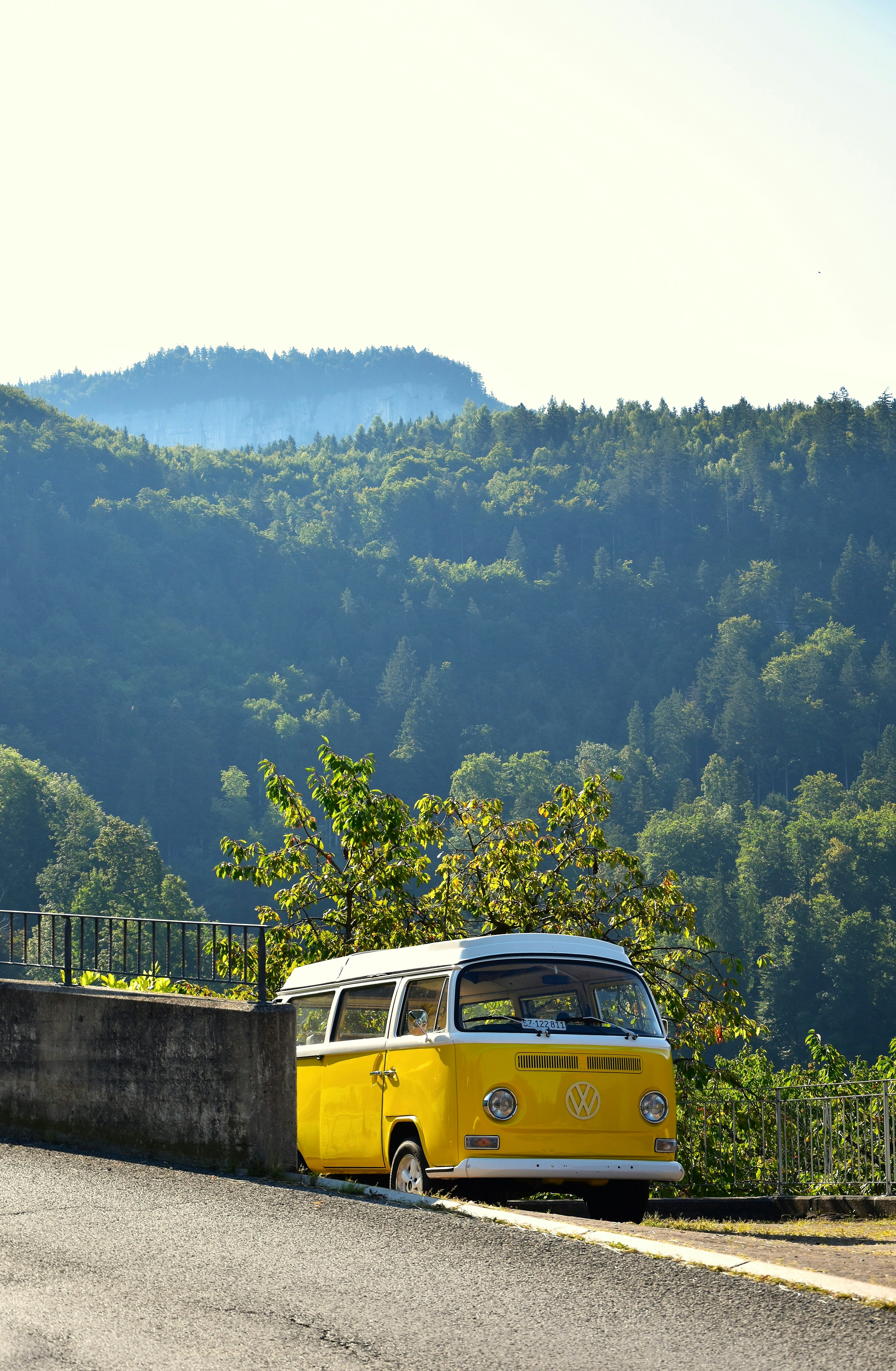 Bright Volkswagen Aventura: A Sunny Yellow Van Pauses on a Mountain Road