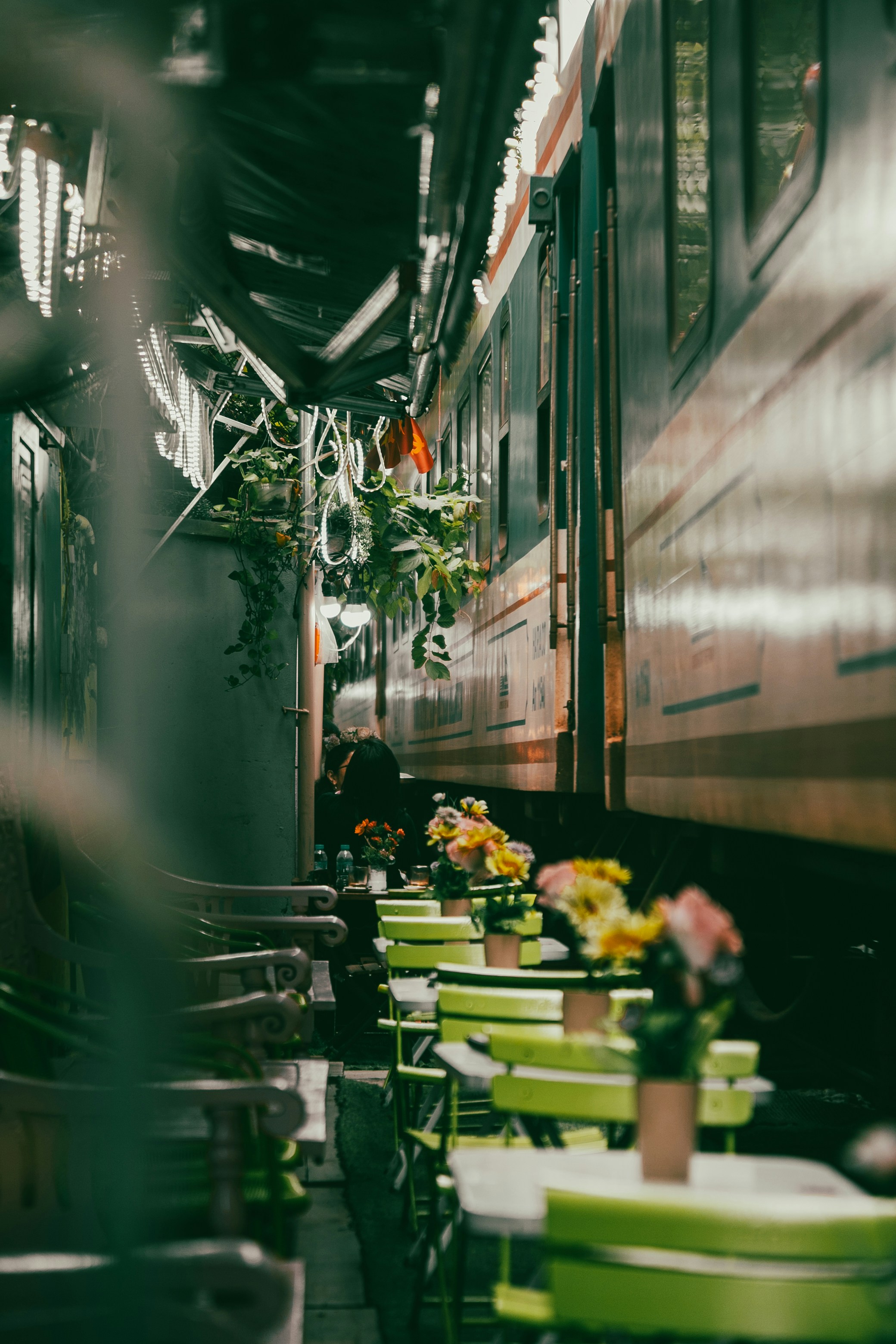 Silent Tables on the Rails: A Neon-Backlit Alley Café Next to a Train