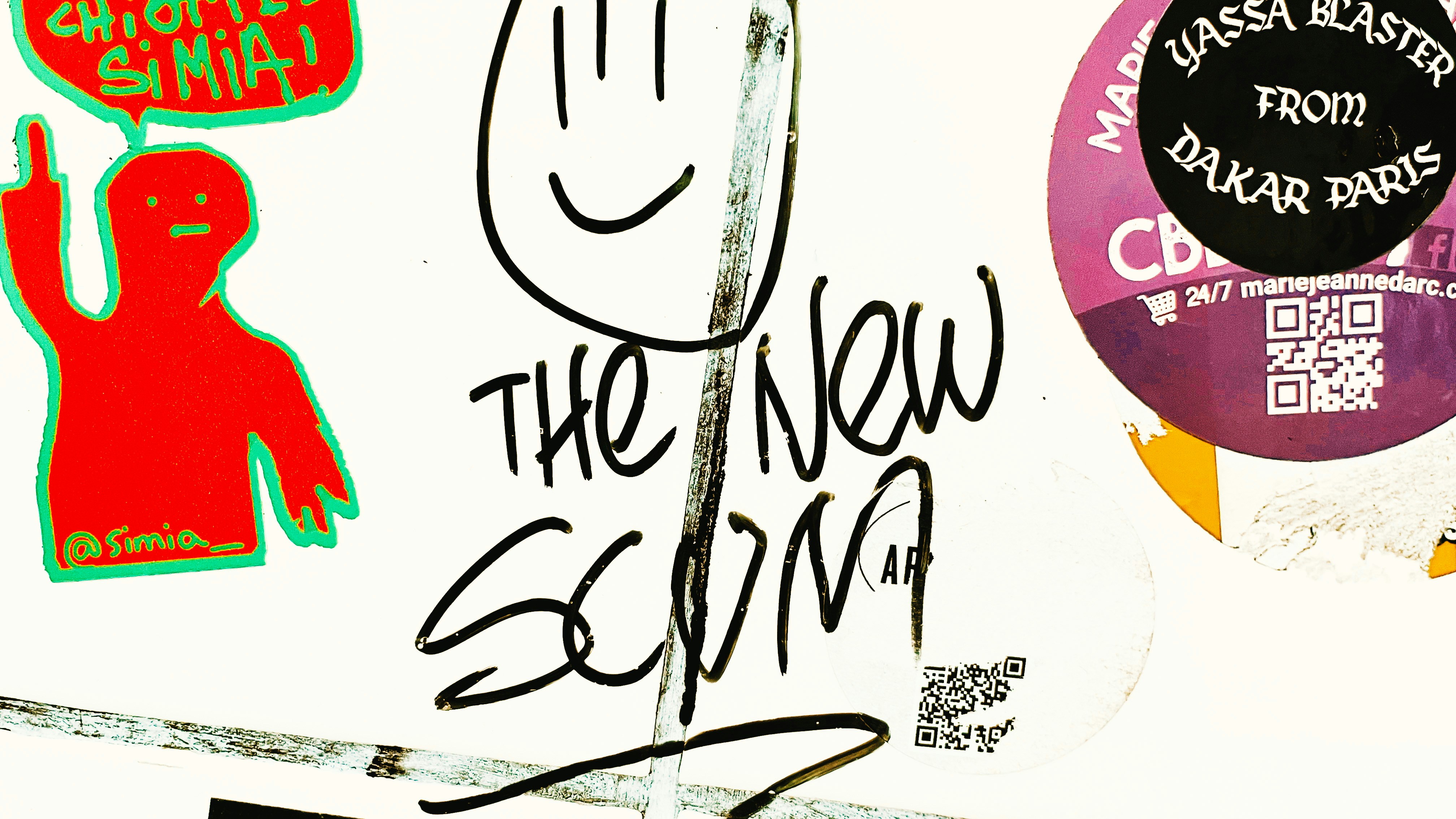 Sticker Garden: Bold Graffiti and Circular Tabs on a White Wall