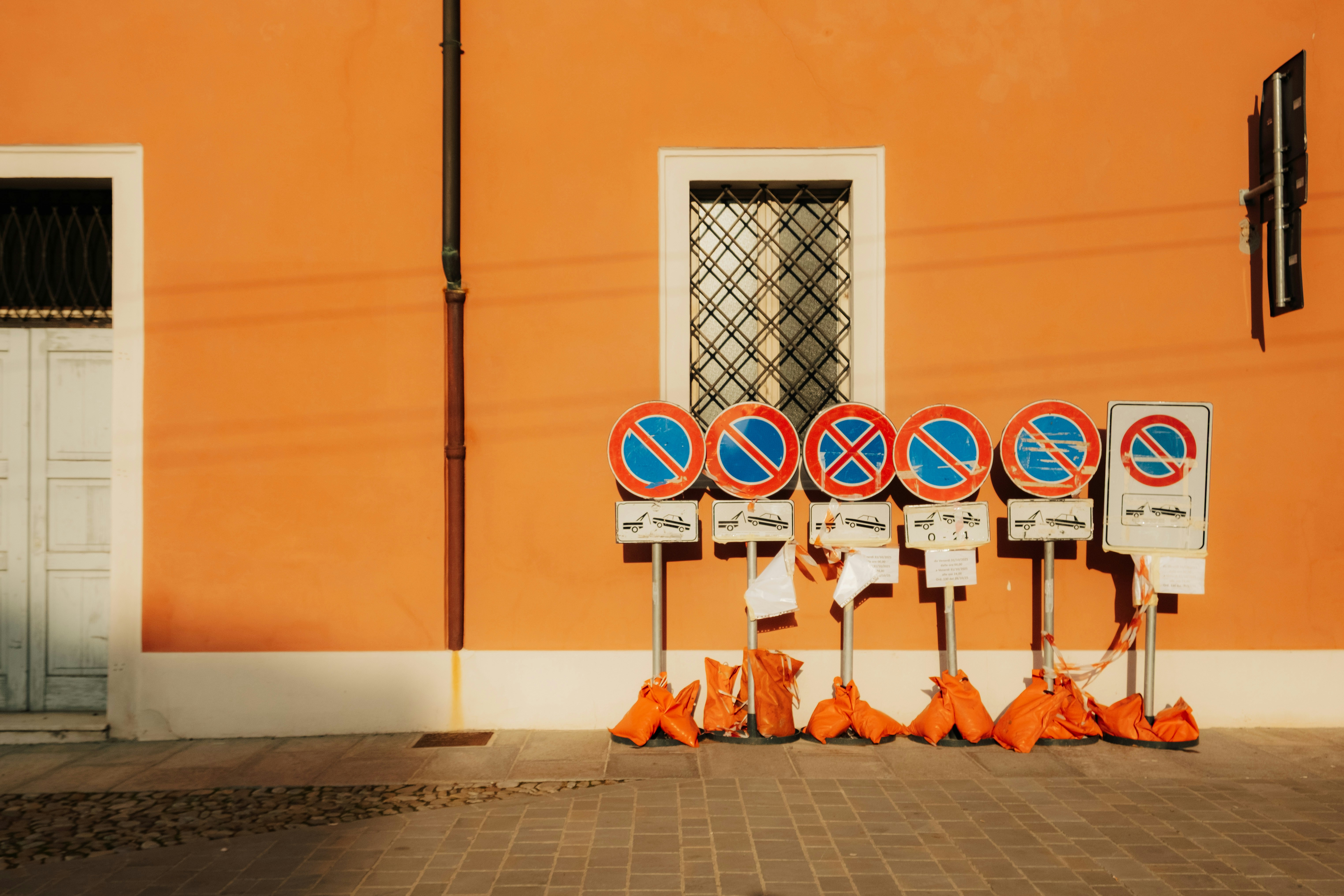Orange Wall, Row of Prohibited Signs, and Sandbag Shadows