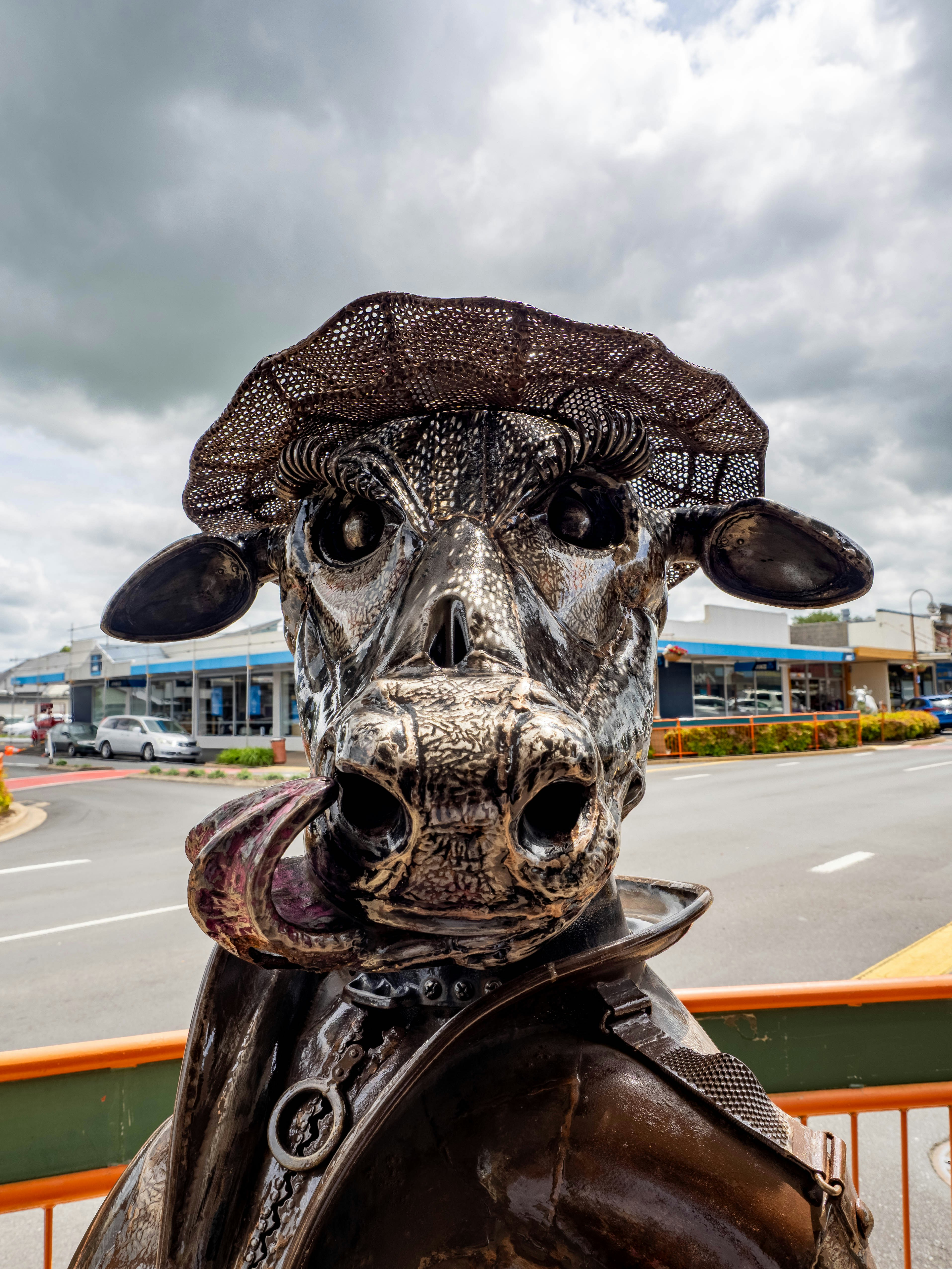 Close-Up of a Tin Sculpture Giraffe’s Head in a Parking Lot