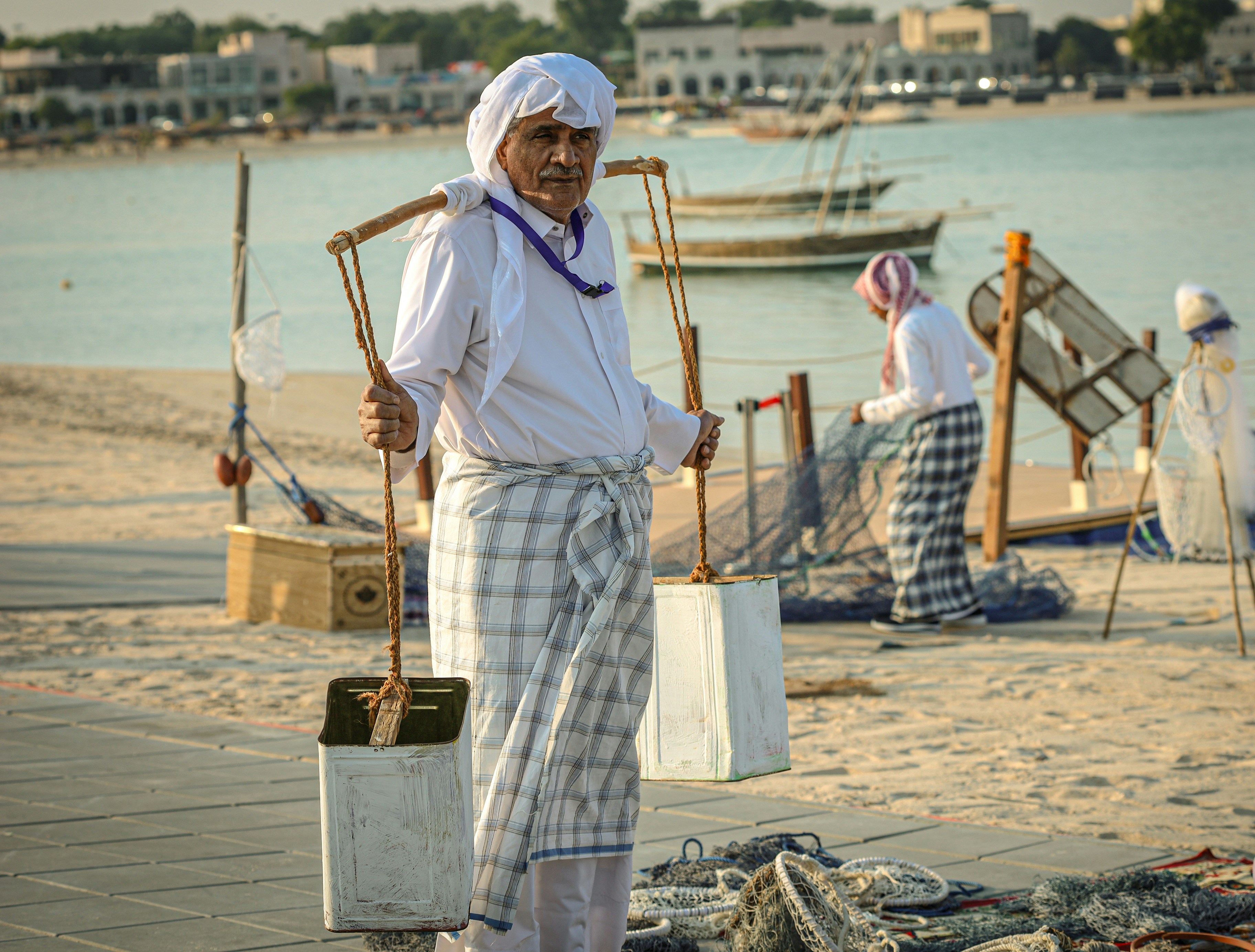 Beach Vendor with Tethered Nets and Salt-White Wrap