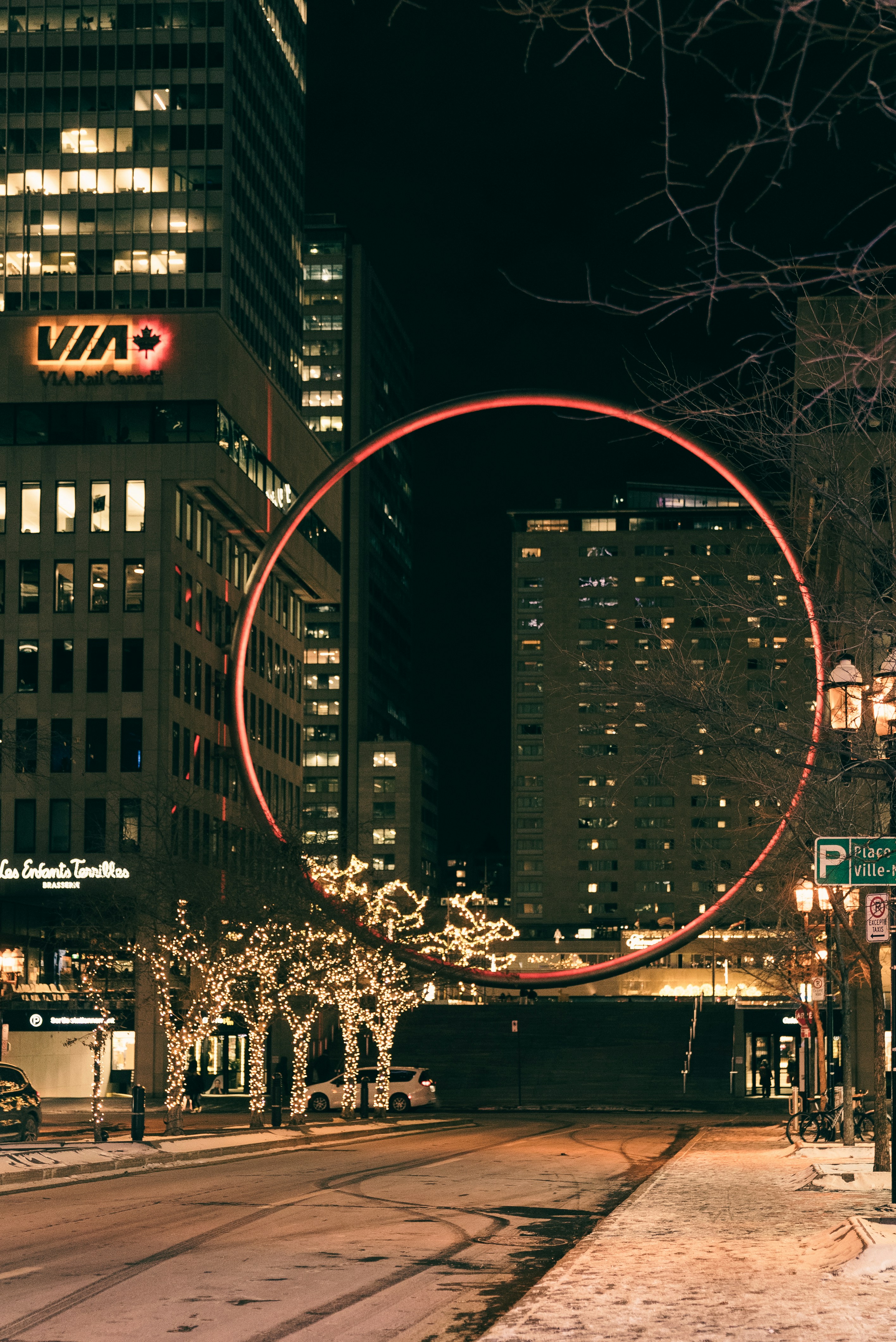 Neon Ring over a Snow-Swept City Street