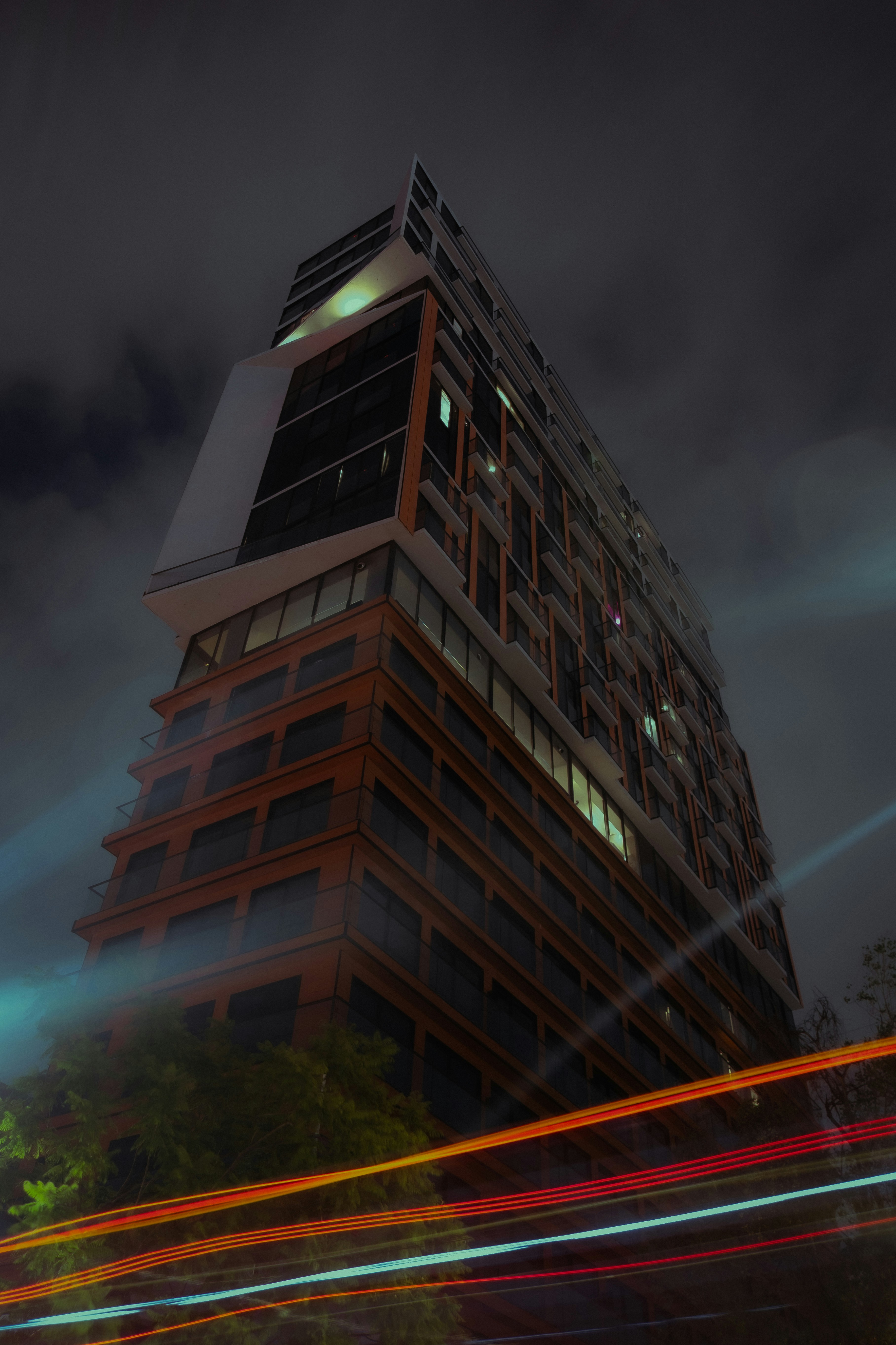Tilted Glass: Nighttime Ascent of a Modern Highrise