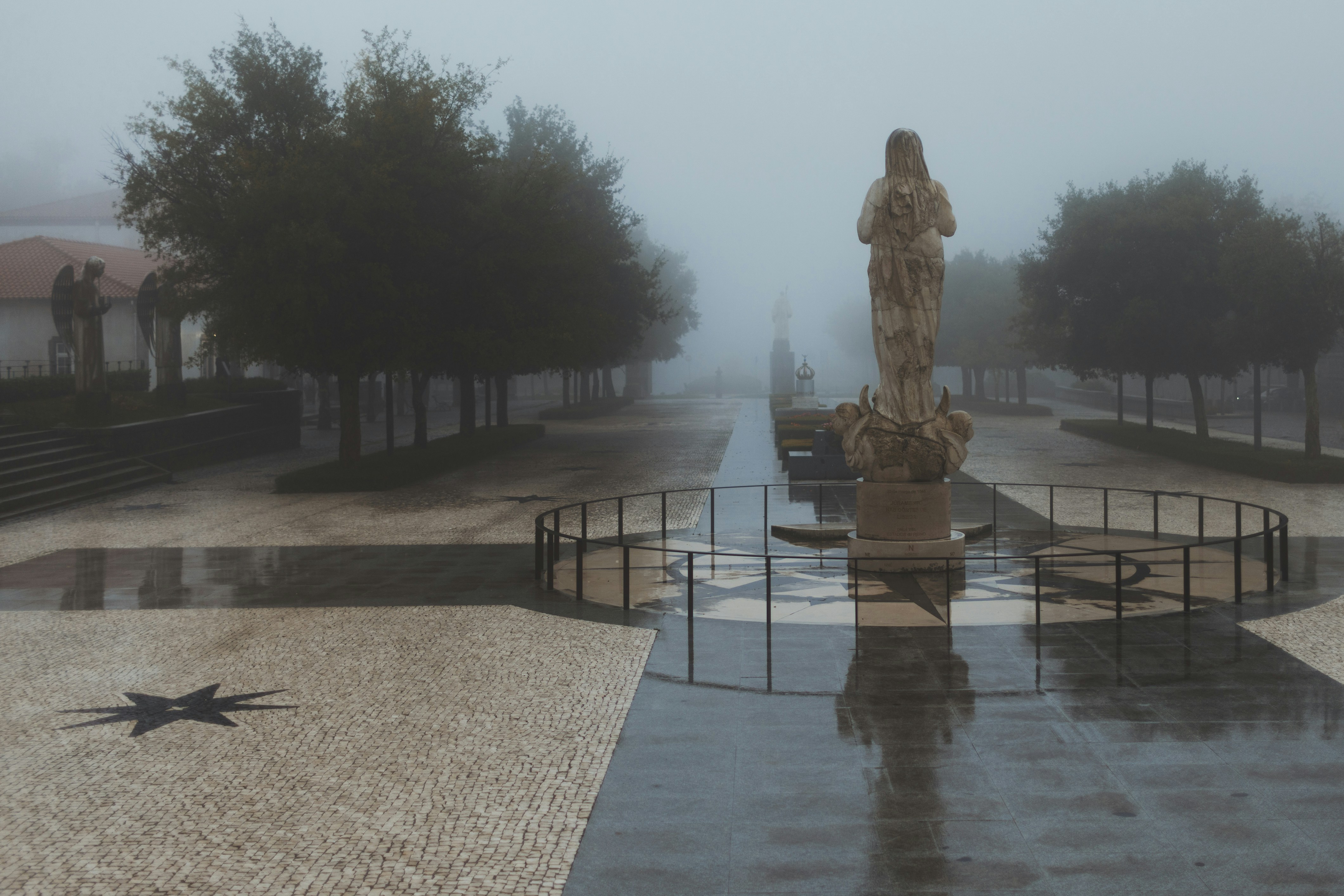 Statue in a Quiet Marble Pathway Fades into Morning Mist