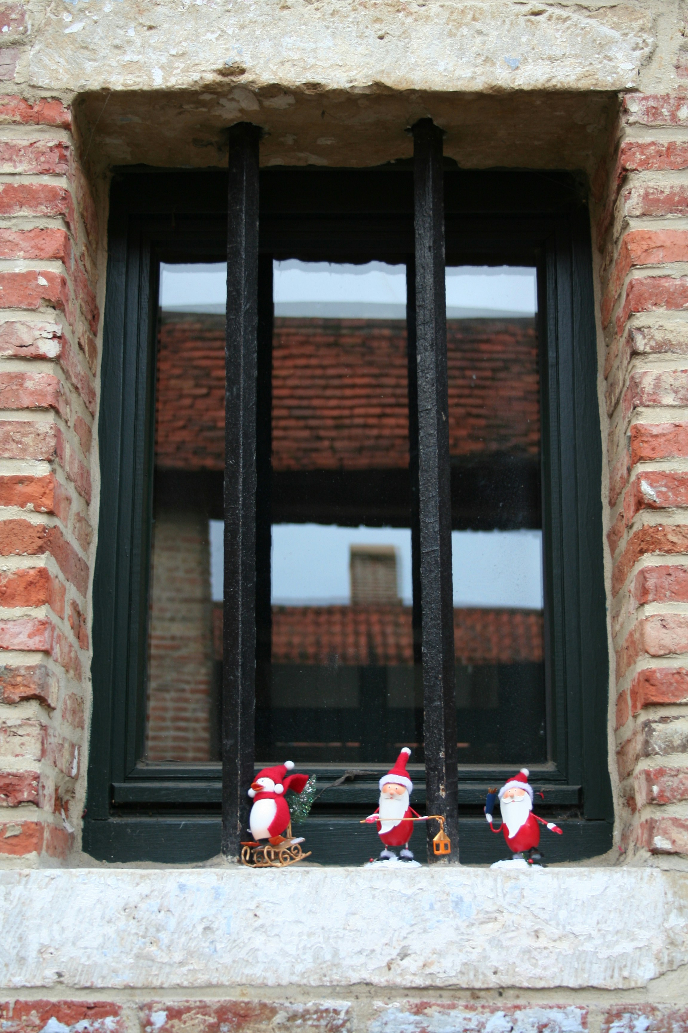 Tiny Santa Figures Guard a Window Like a Seasonal Portal
