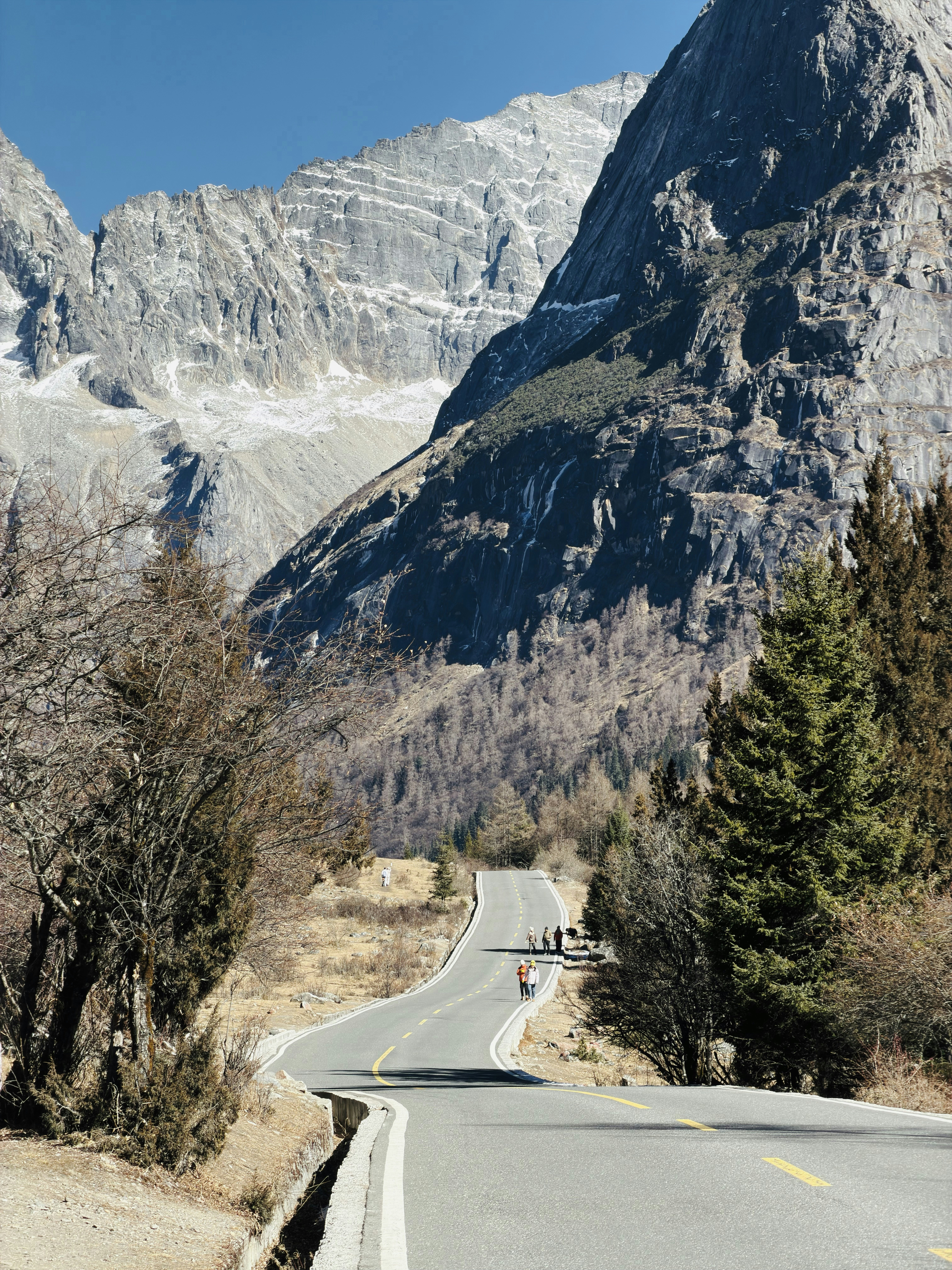 Winding Mountain Road Toward a Cliff-Village Horizon