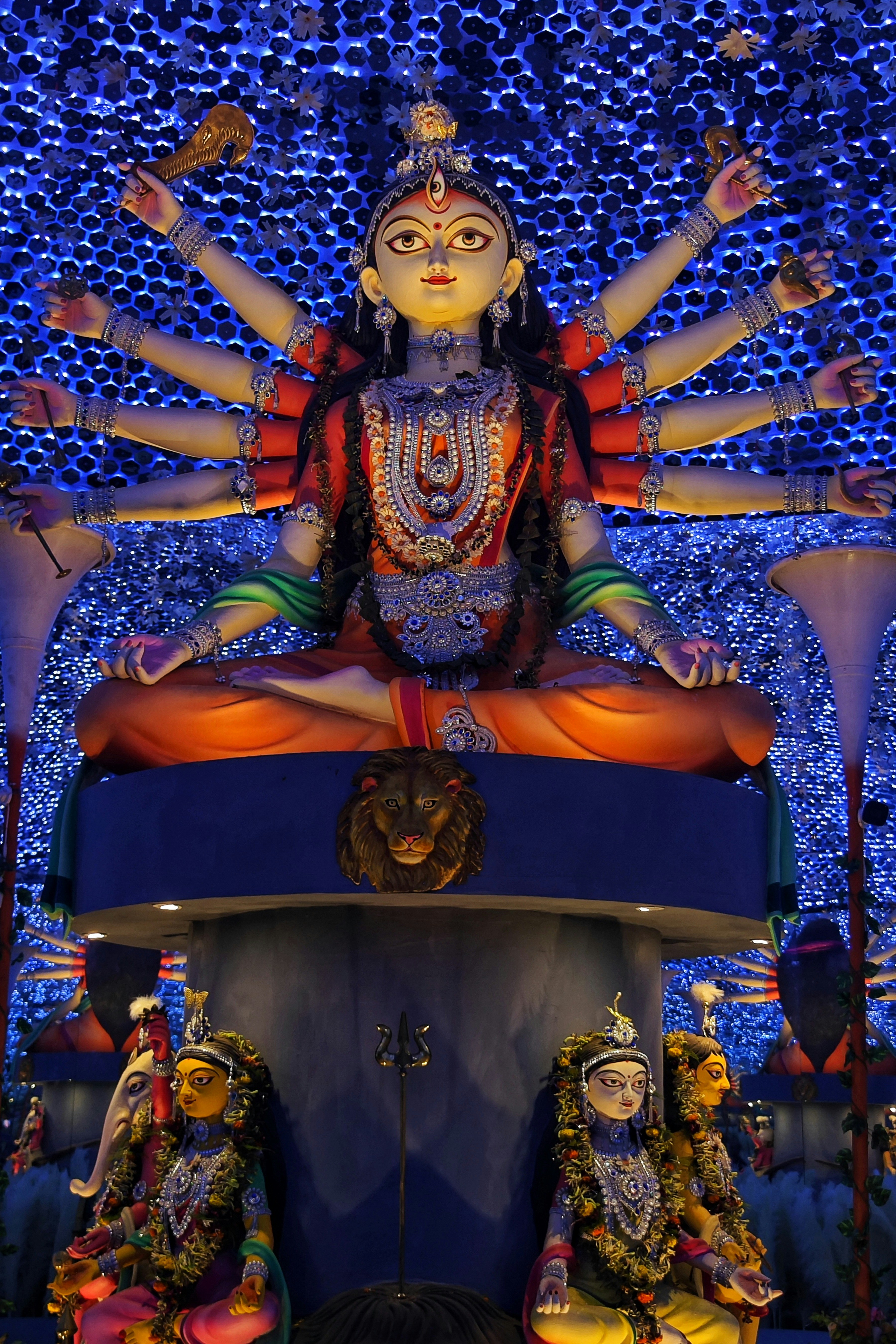 Divine Multitude: A Sculpted Goddess Surrounded by Blue Lustre