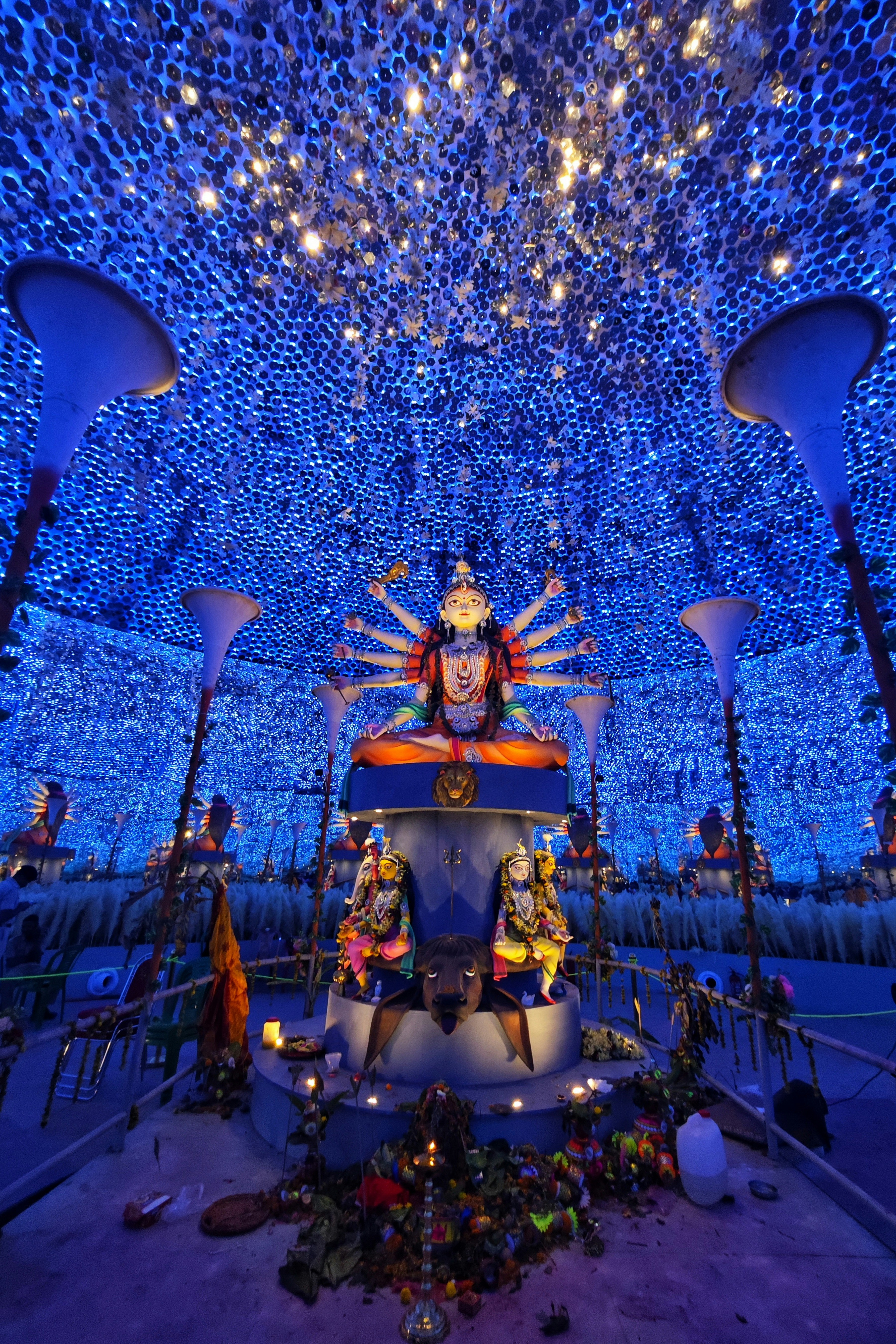 Blue Lit Temple Shrine: Multilayered Deity Centered Under a Sea of Lights