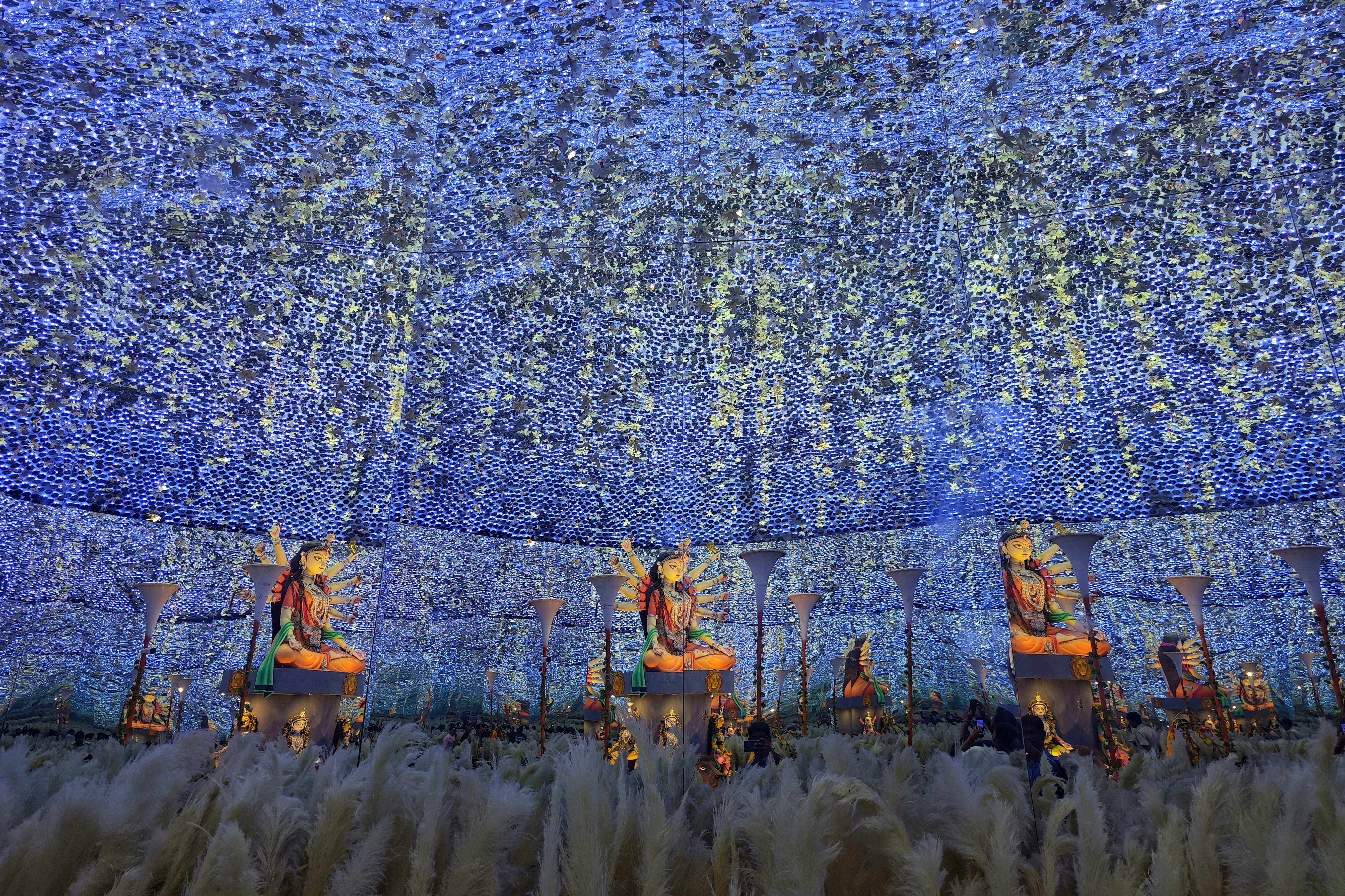 Buddha statues illuminated by blue lights.