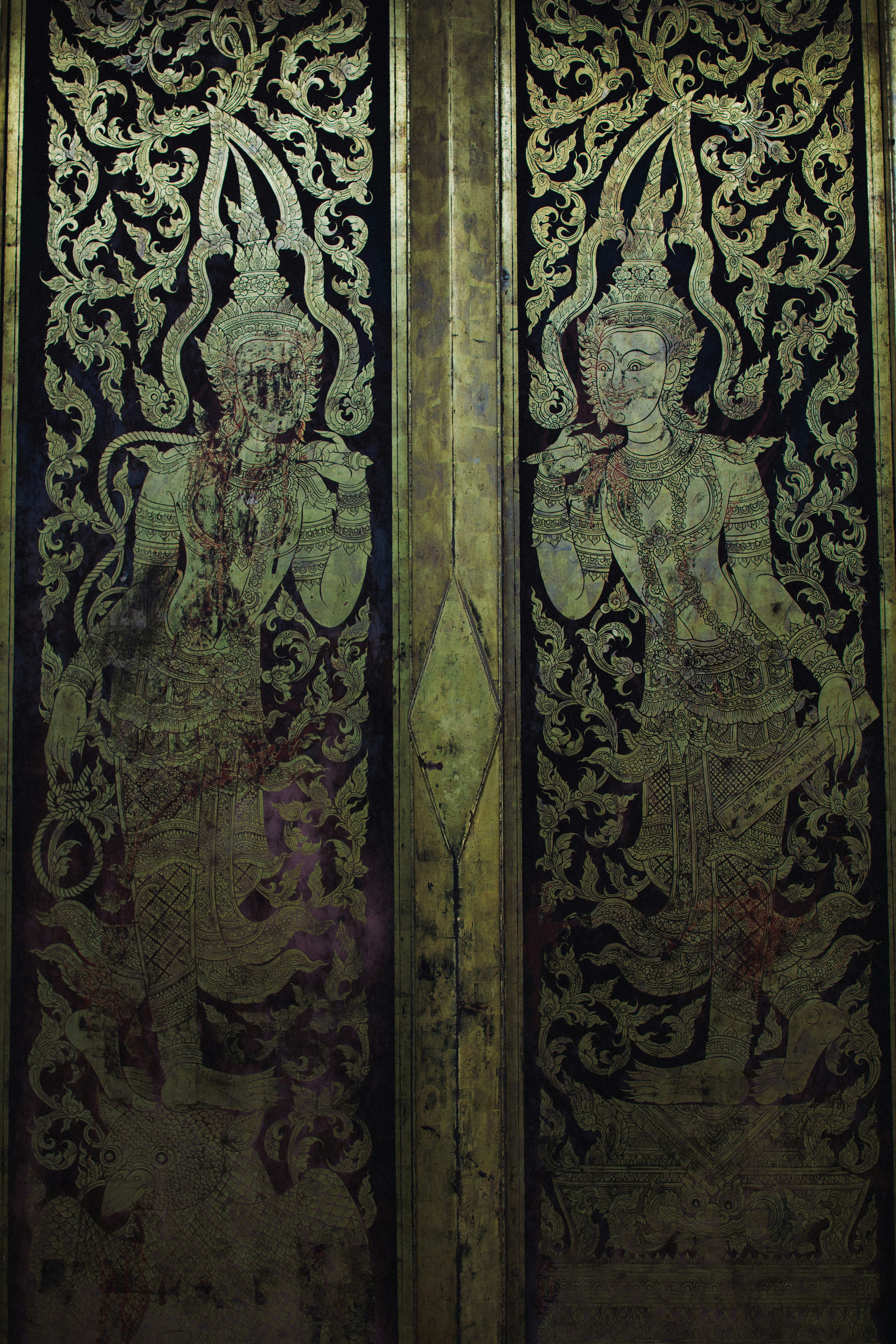 Dual Gate Guardians: Ornate Door Panels Adorned with Mythic Figures