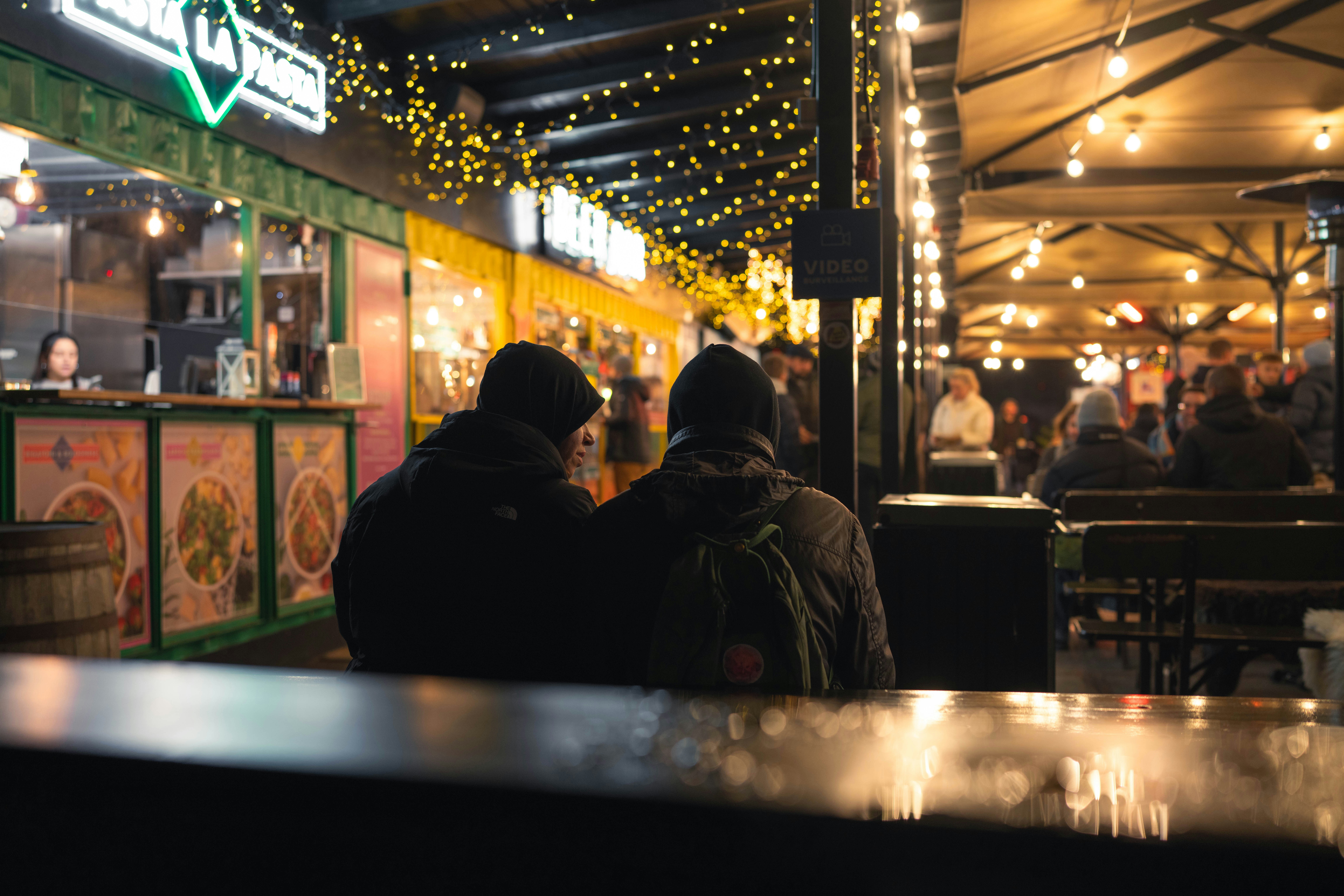 People sit at outdoor food stalls at night. photo – Free Winter Image ...
