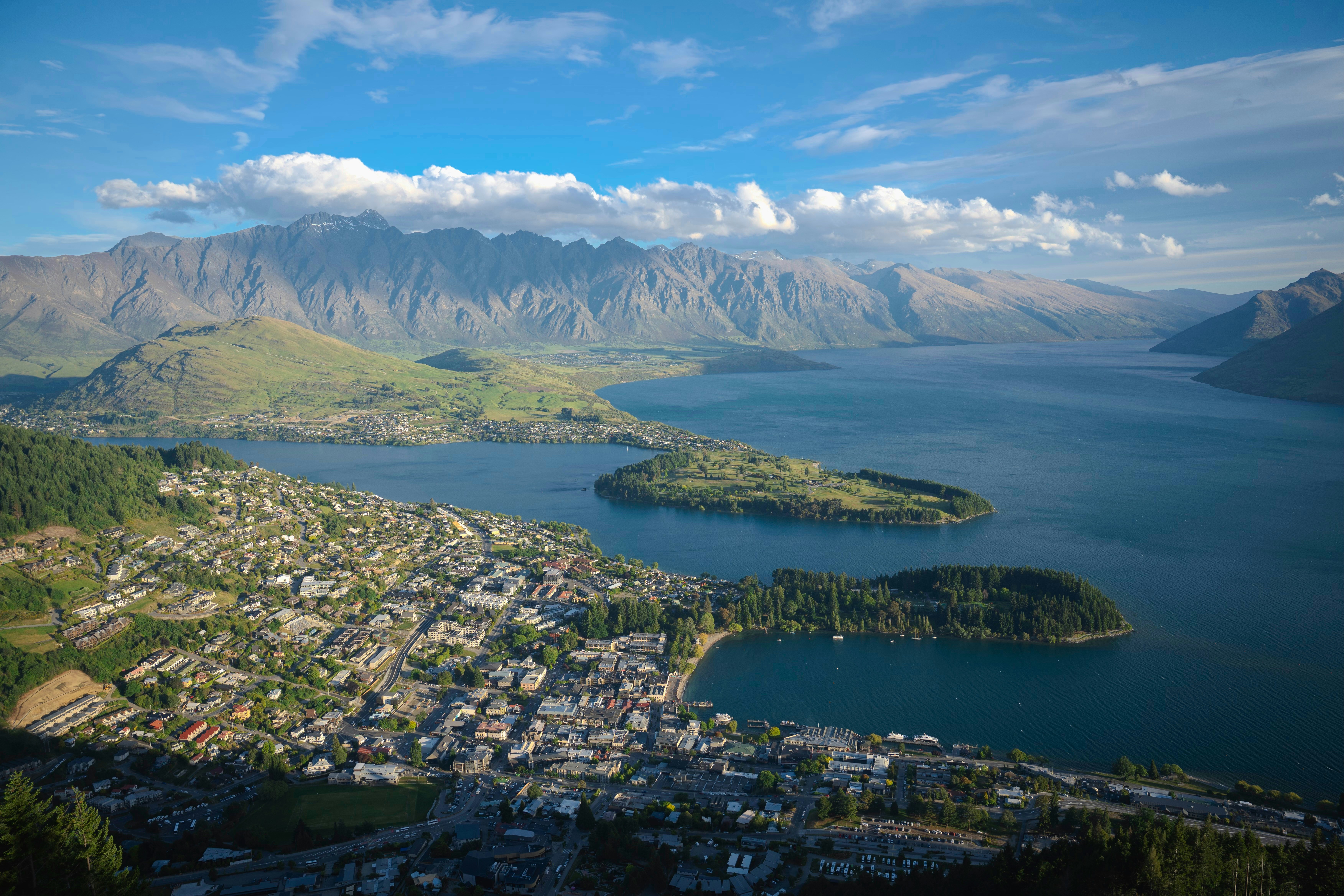 Aerial Confluence: Fjord, Town, and Mountain Ridge