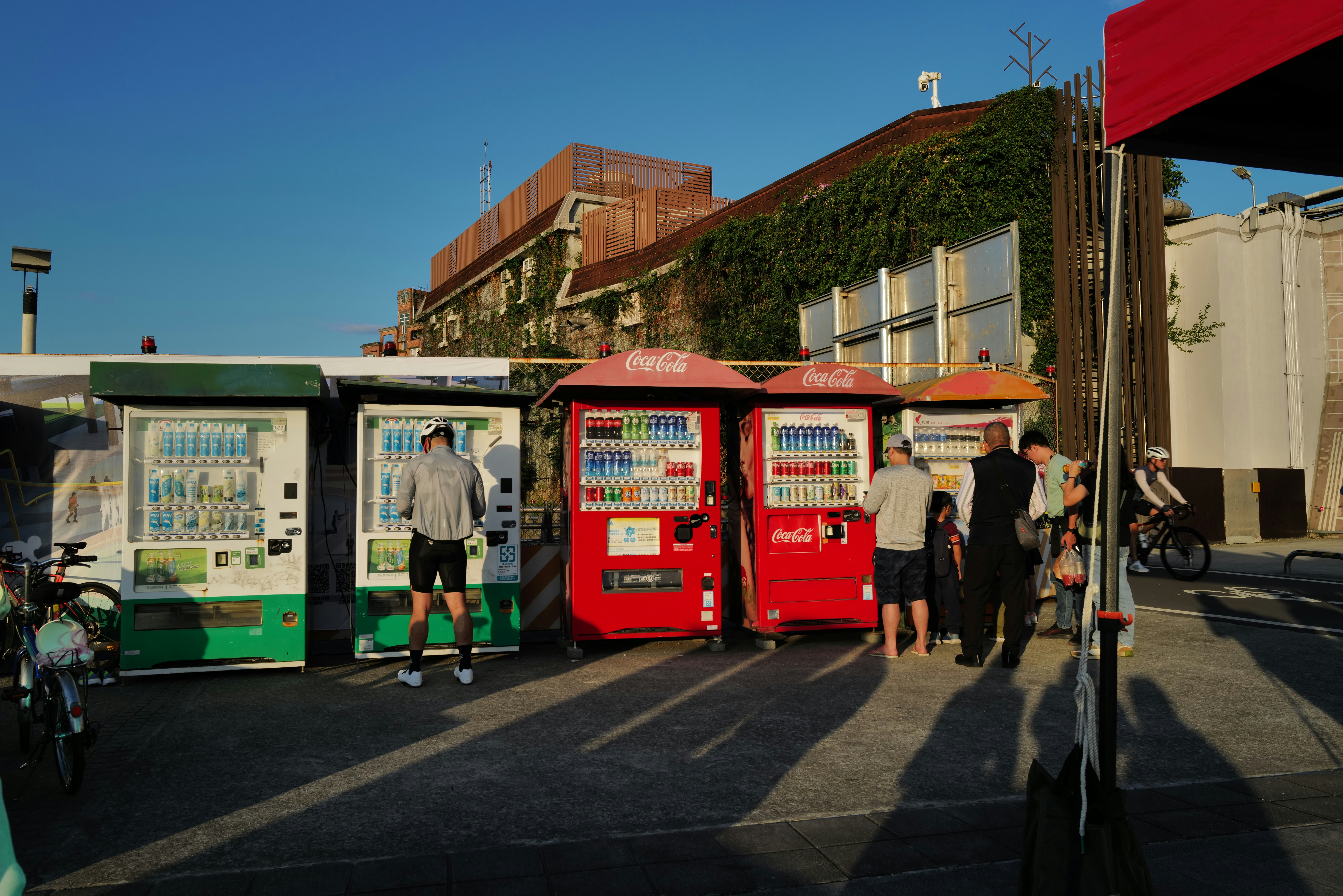 Vending Street: Colorful Cans and Cast Shadows in Afternoon Light