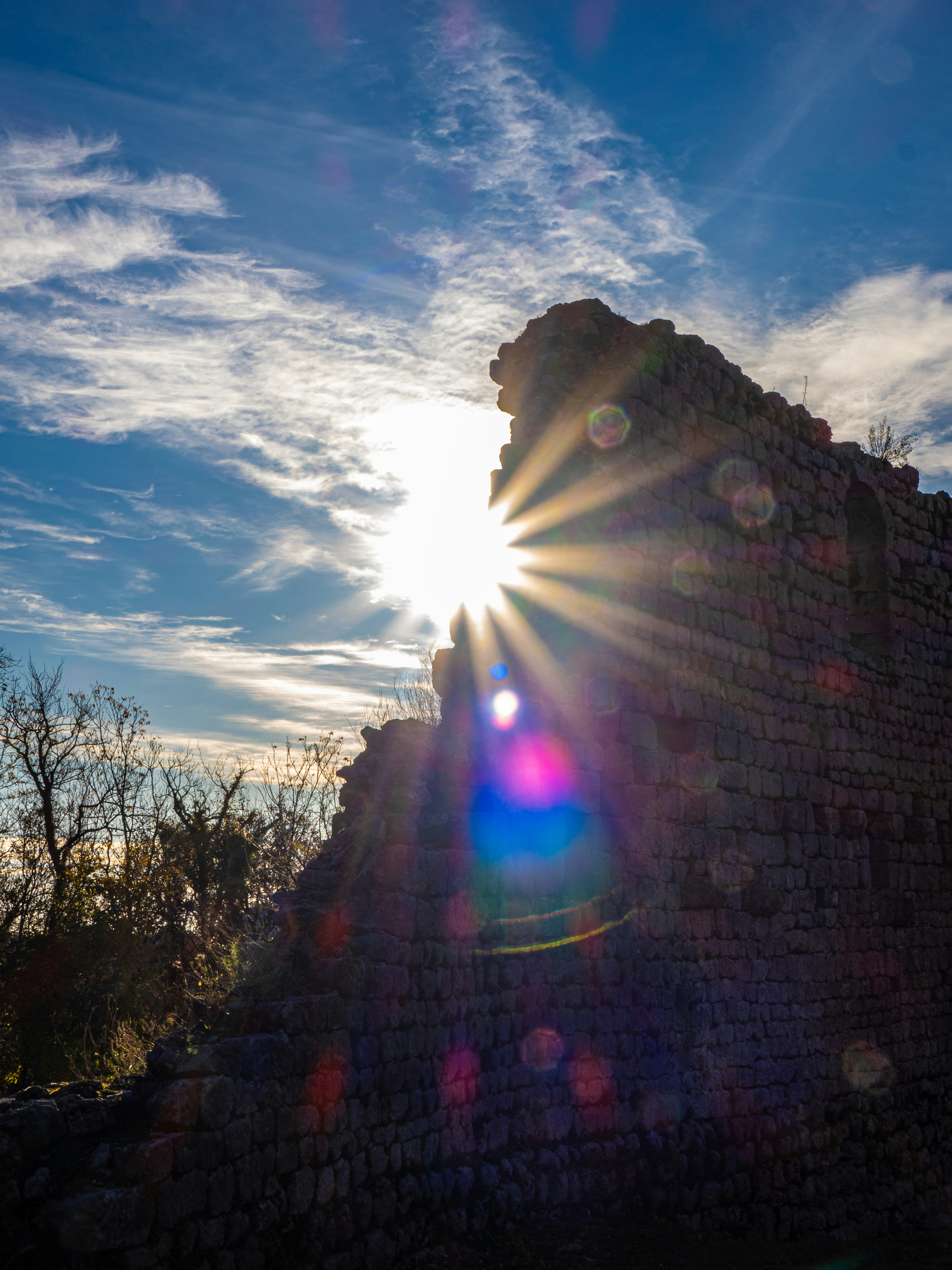 Sunburst Through Ancient Stones: A Ruin Silhouette at Dusk