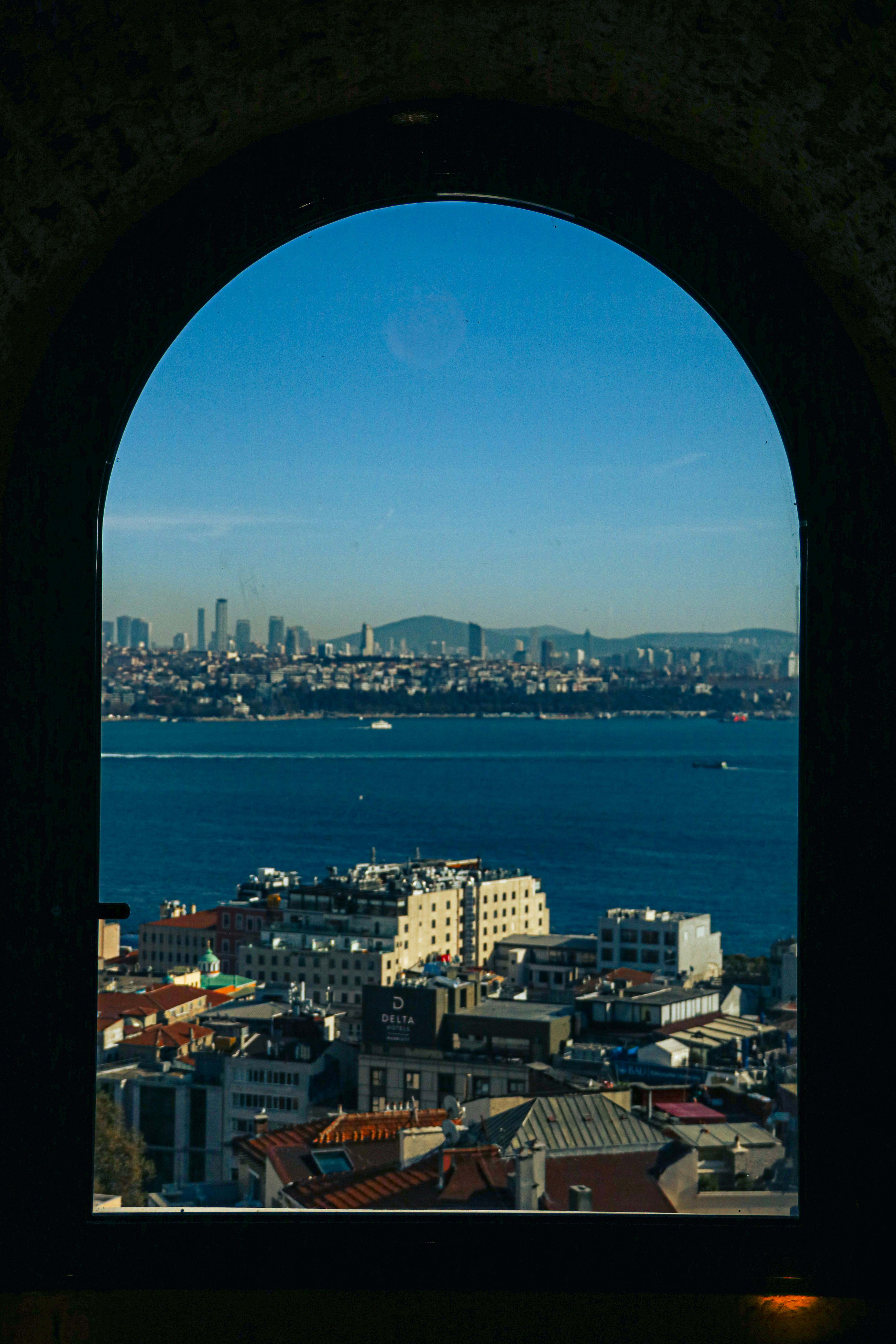 Archway to the City: Harbor Vista Framed by a Dark Arch