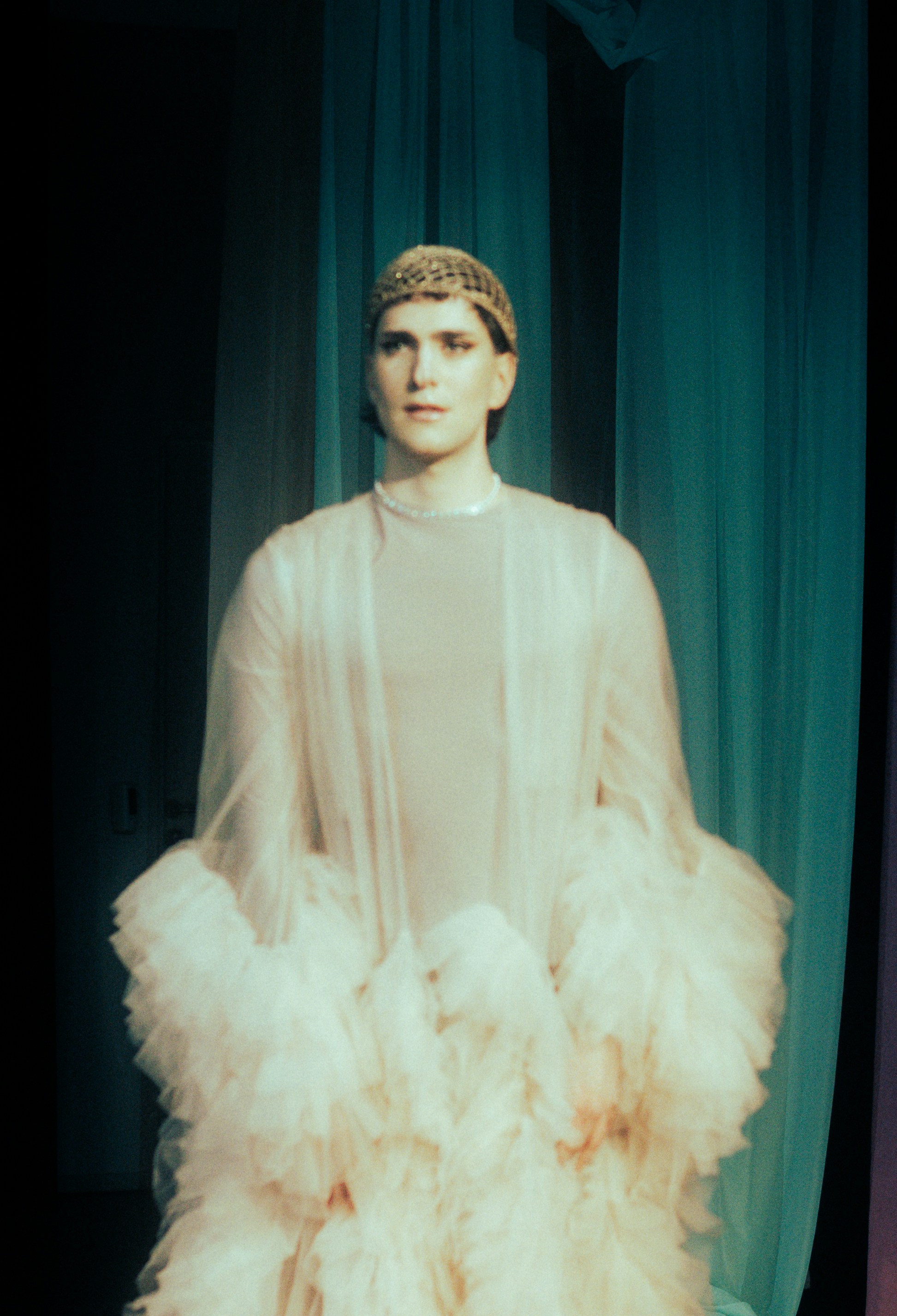 Gown in Soft Illumination: A Portrait through Veiled Drapes