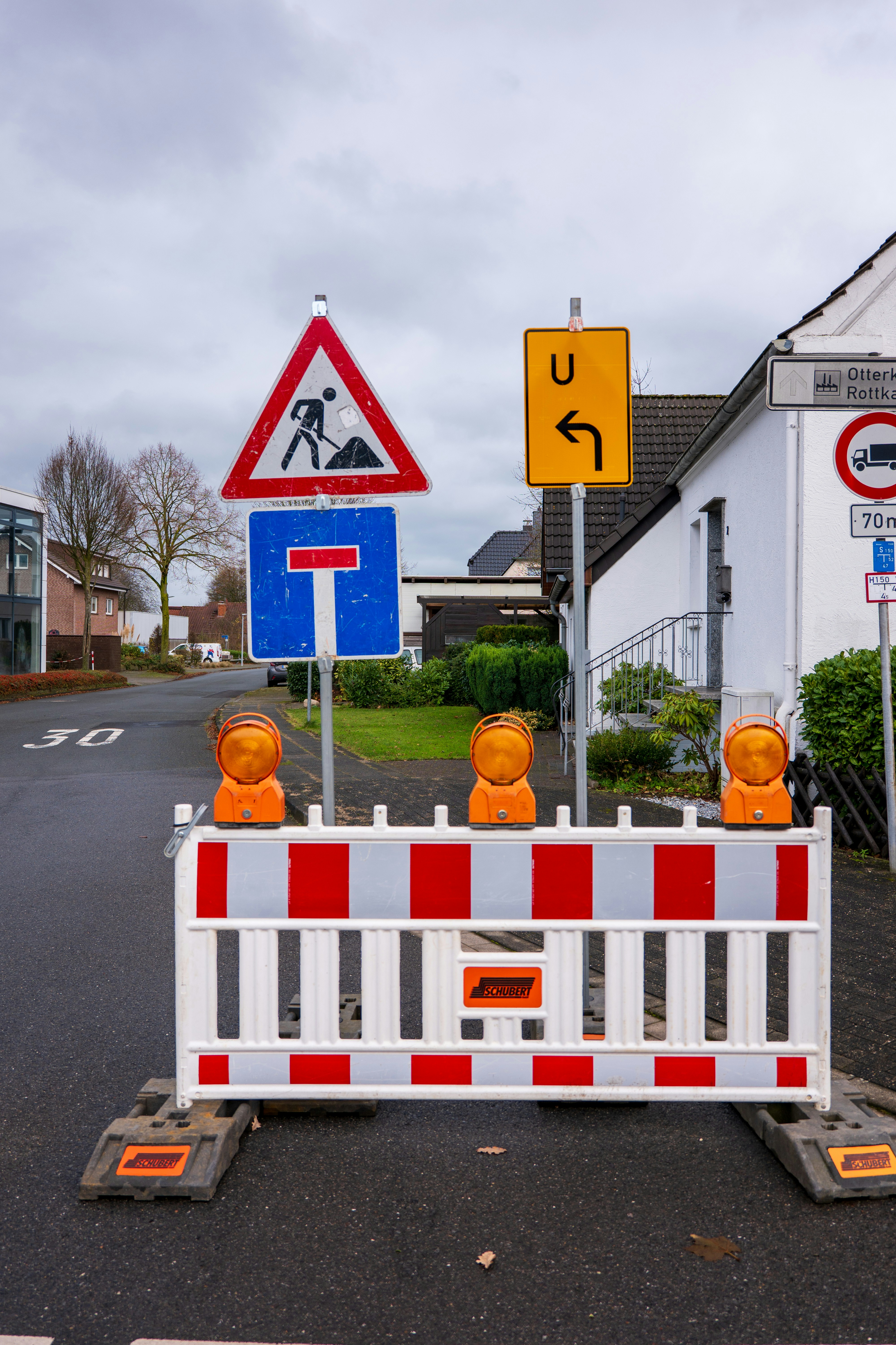 Road construction signs and barrier on a street photo – Free ...