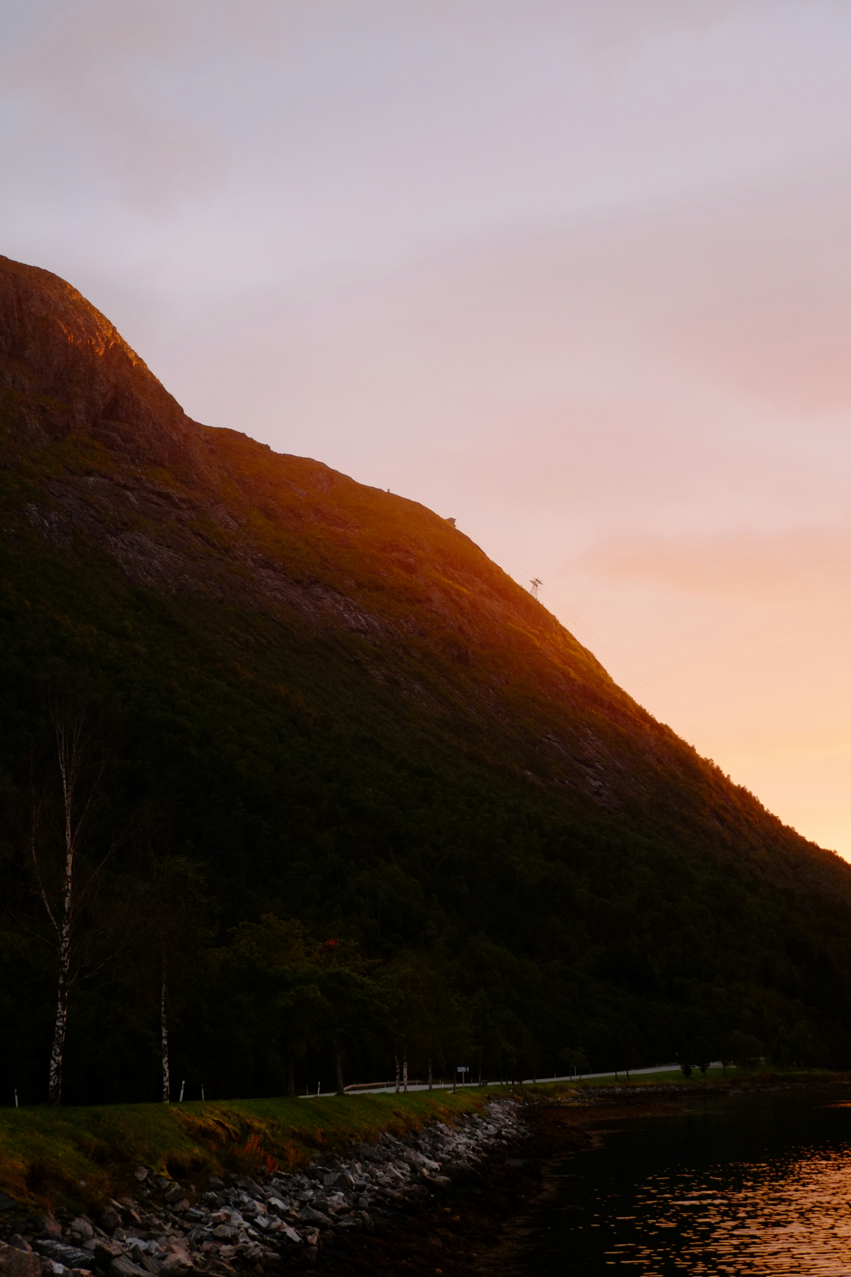 Dusk Climb: The Sunlit Ridge Beyond a Quiet Loch