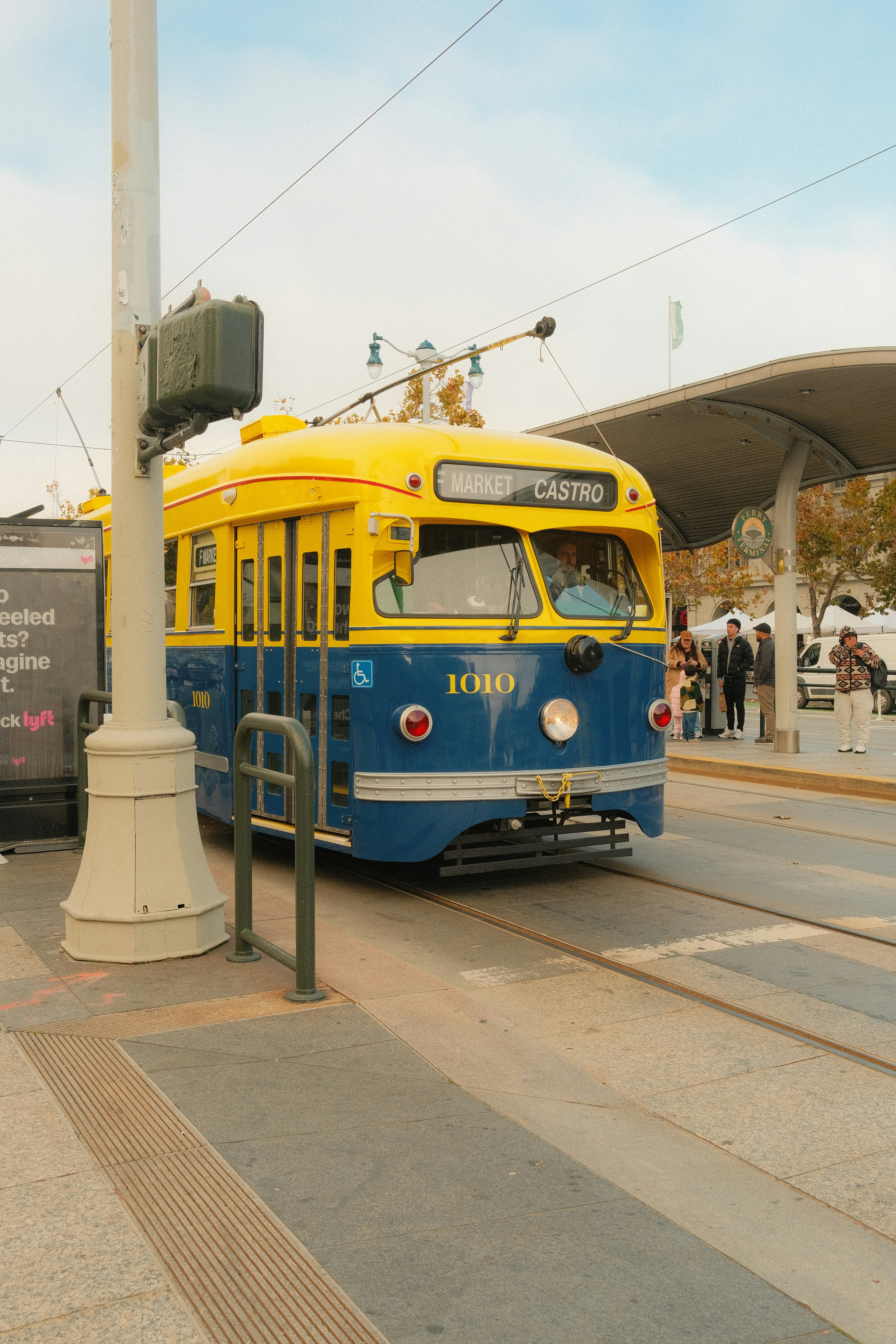 Blue-Leafed Heritage: A Vintage Streetcar at the Platform