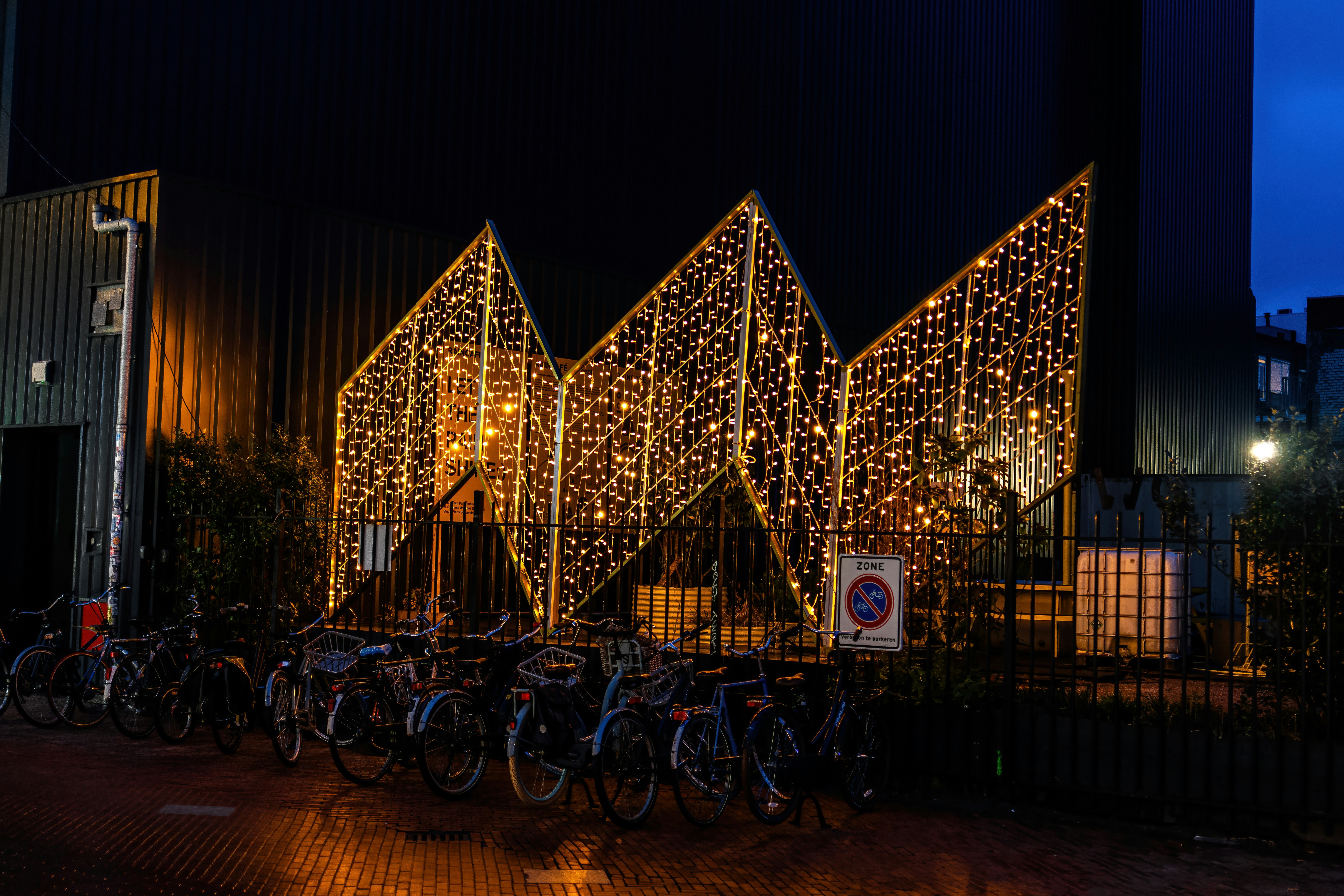 Glowing Geometric Constellation Behind a Row of Bikes