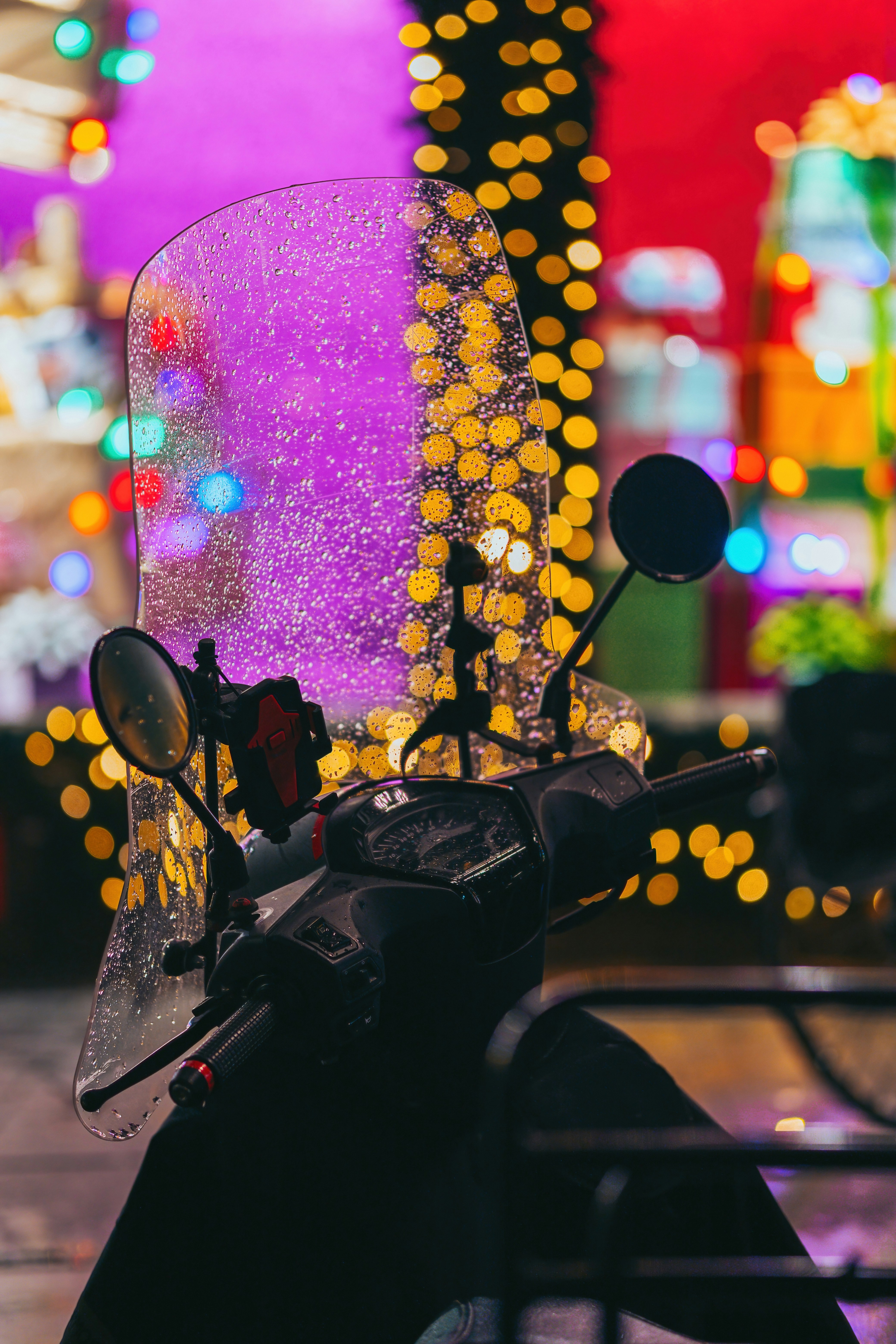 Glittering Windshield, Neon Night: A Scooter in the Lights