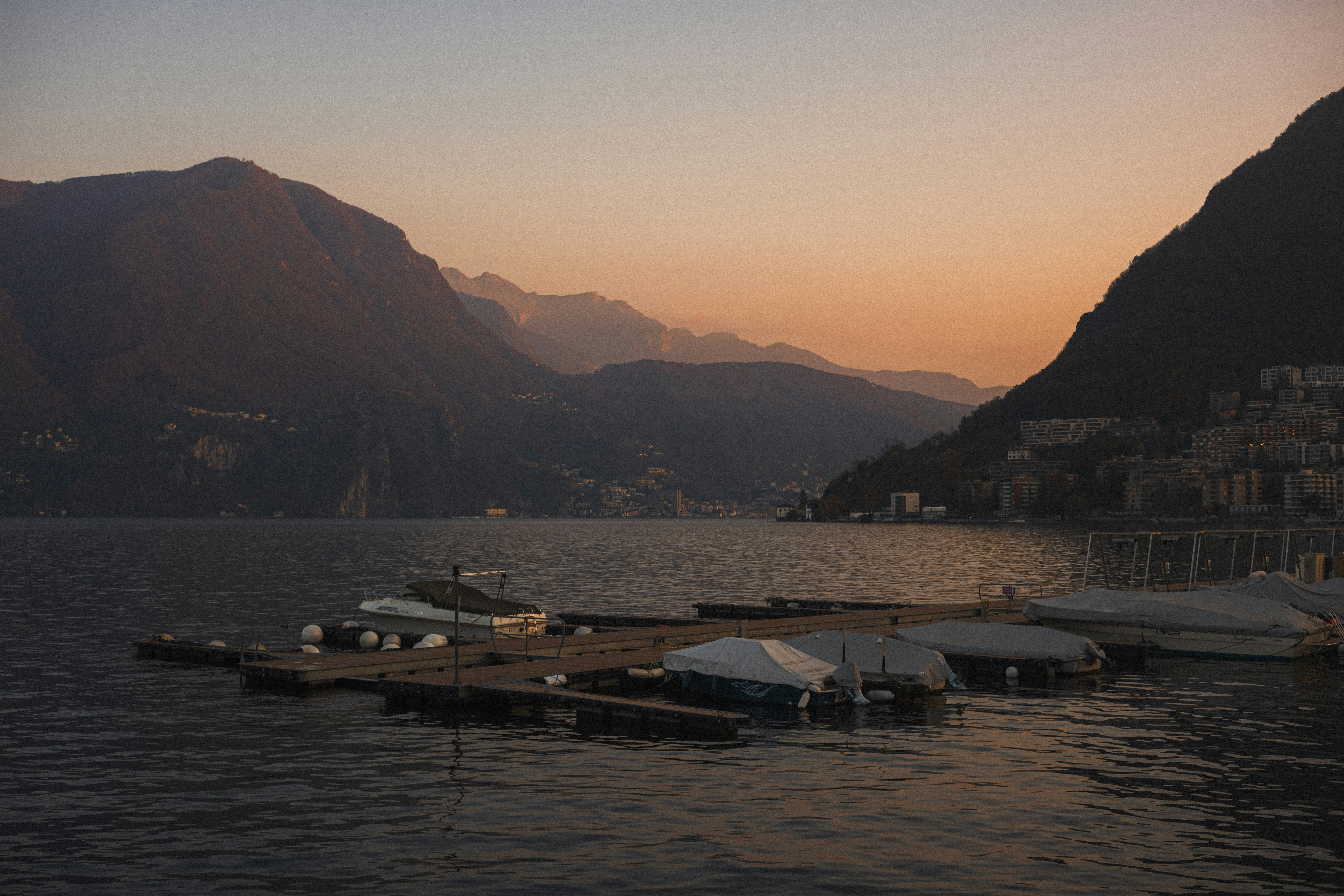 Sunset on the Bellagio Inlet: Boats and Distant Town beneath Quiet Peaks