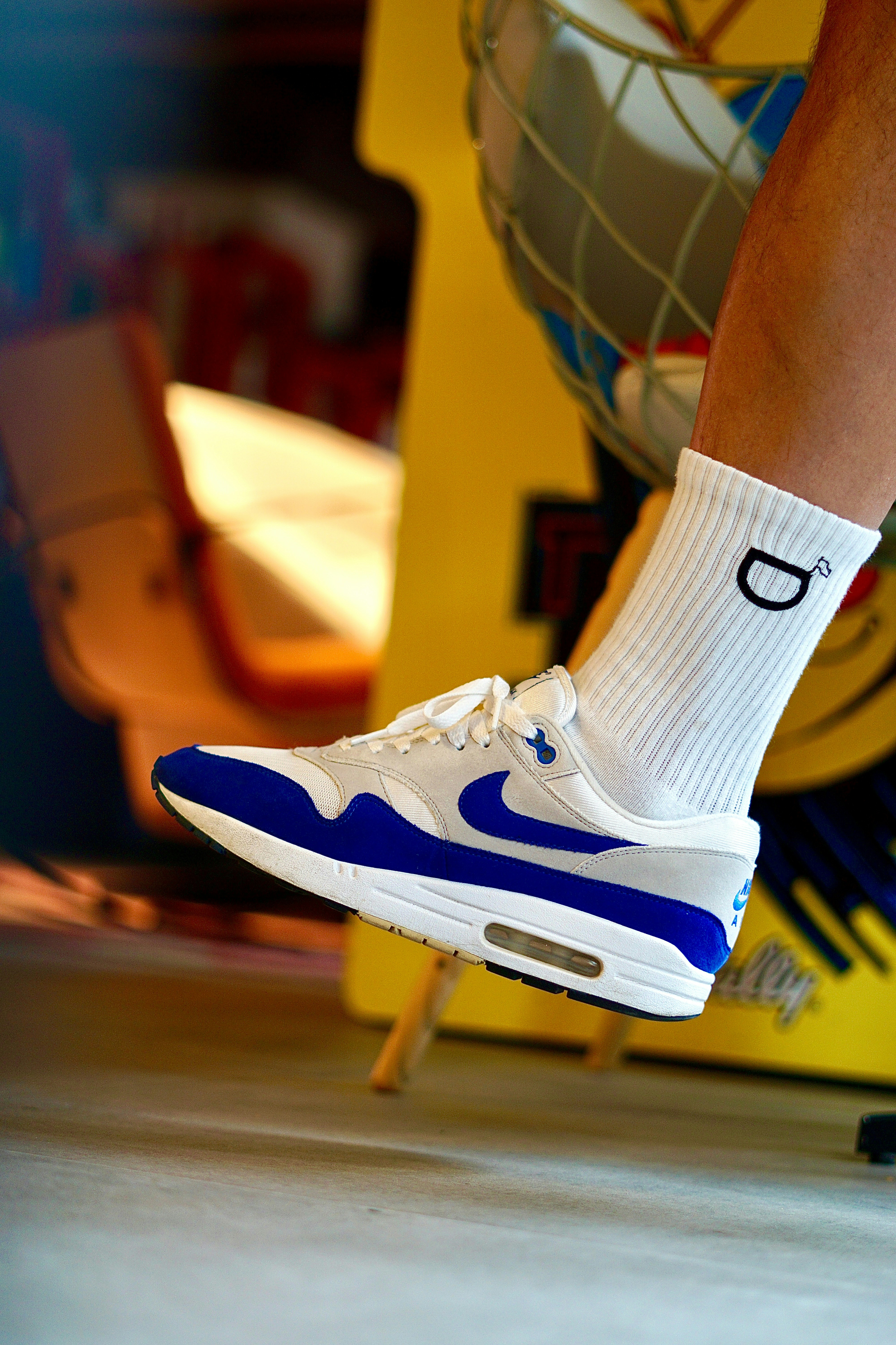 Blue-Trim Sneaker in Action under a Playful Backdrop