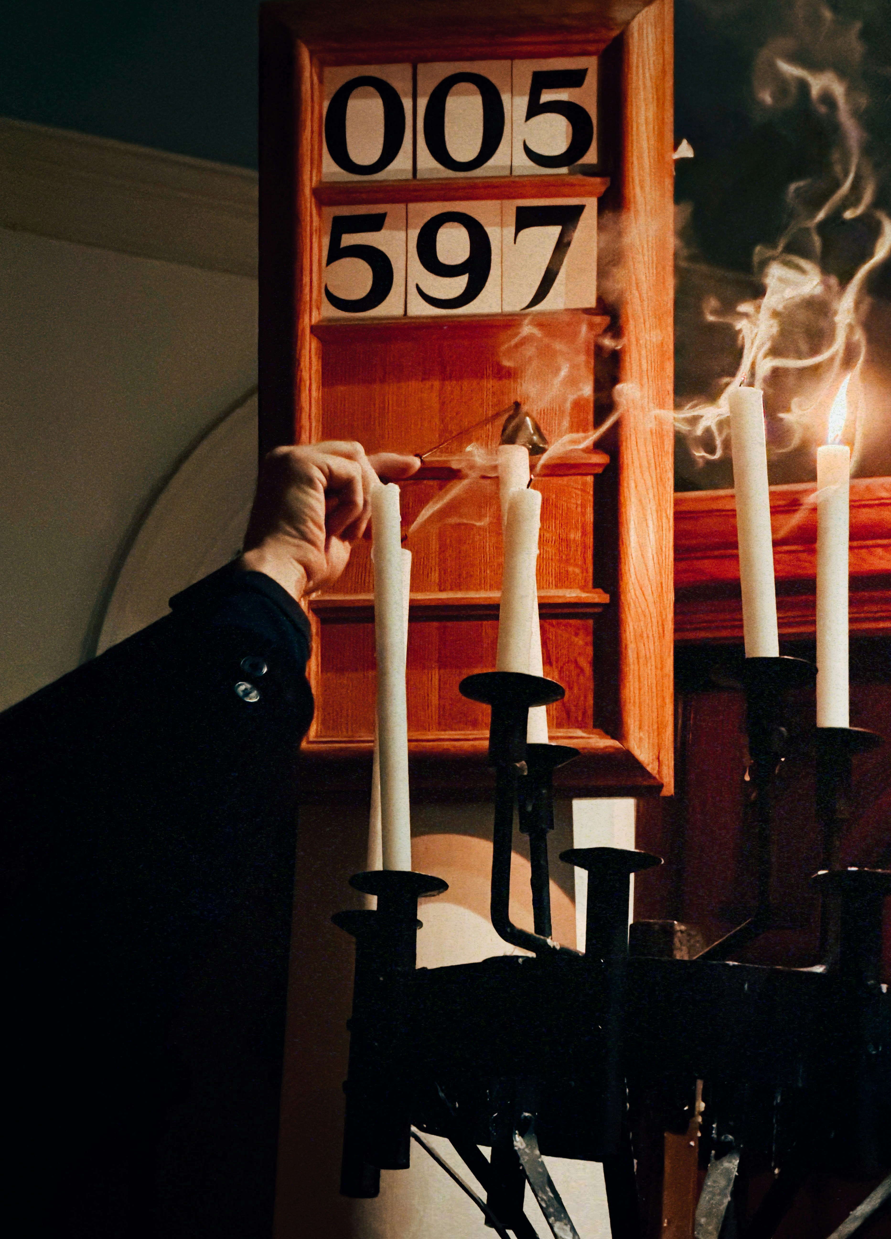 Candlelit Vigil Near a Wooden Number Board