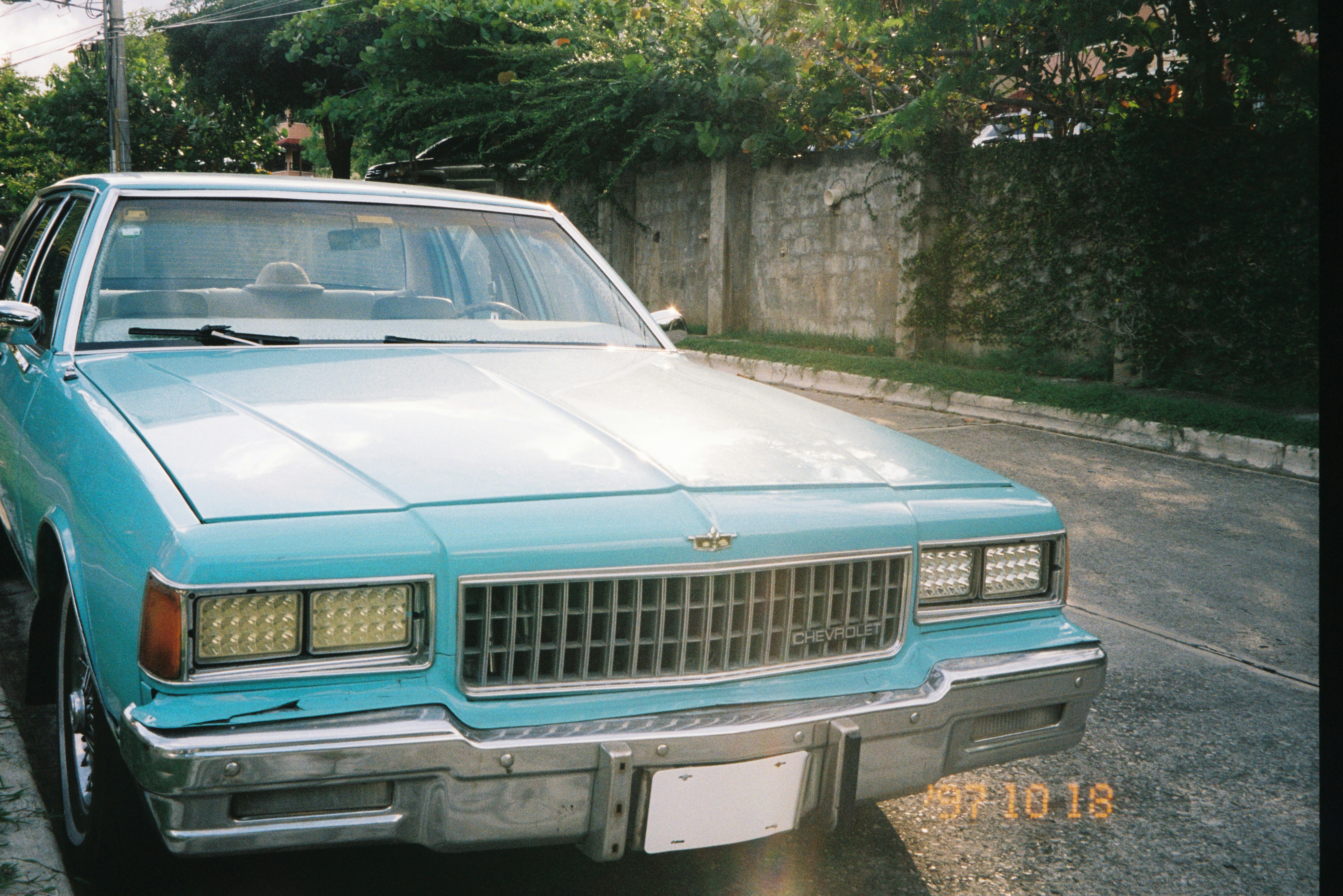 Aqua Vintage: The Turquoise Buick Beckons on a Quiet Street