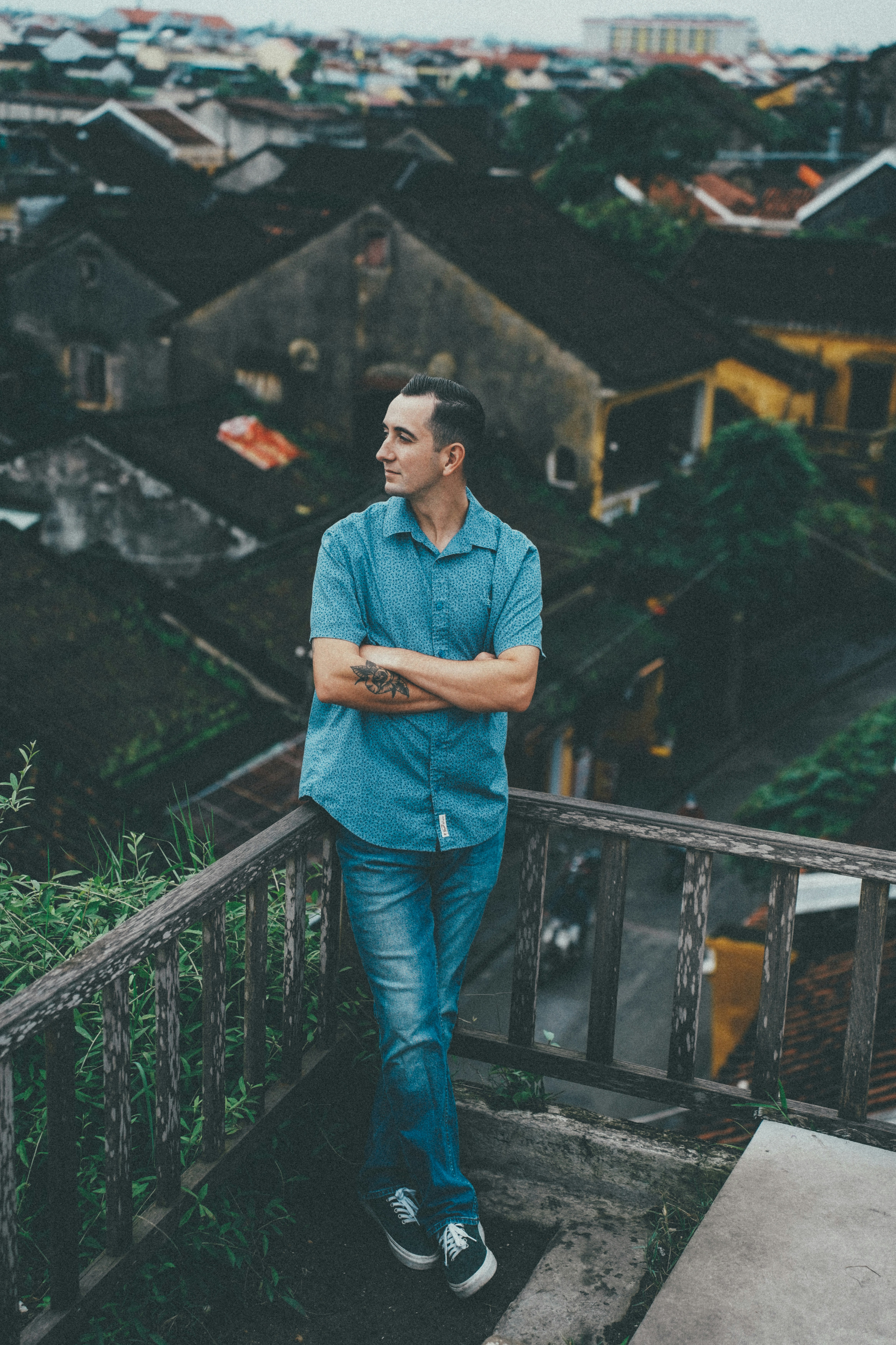 Crossed Arms, Quiet Confidence on a Rooftop Overlook