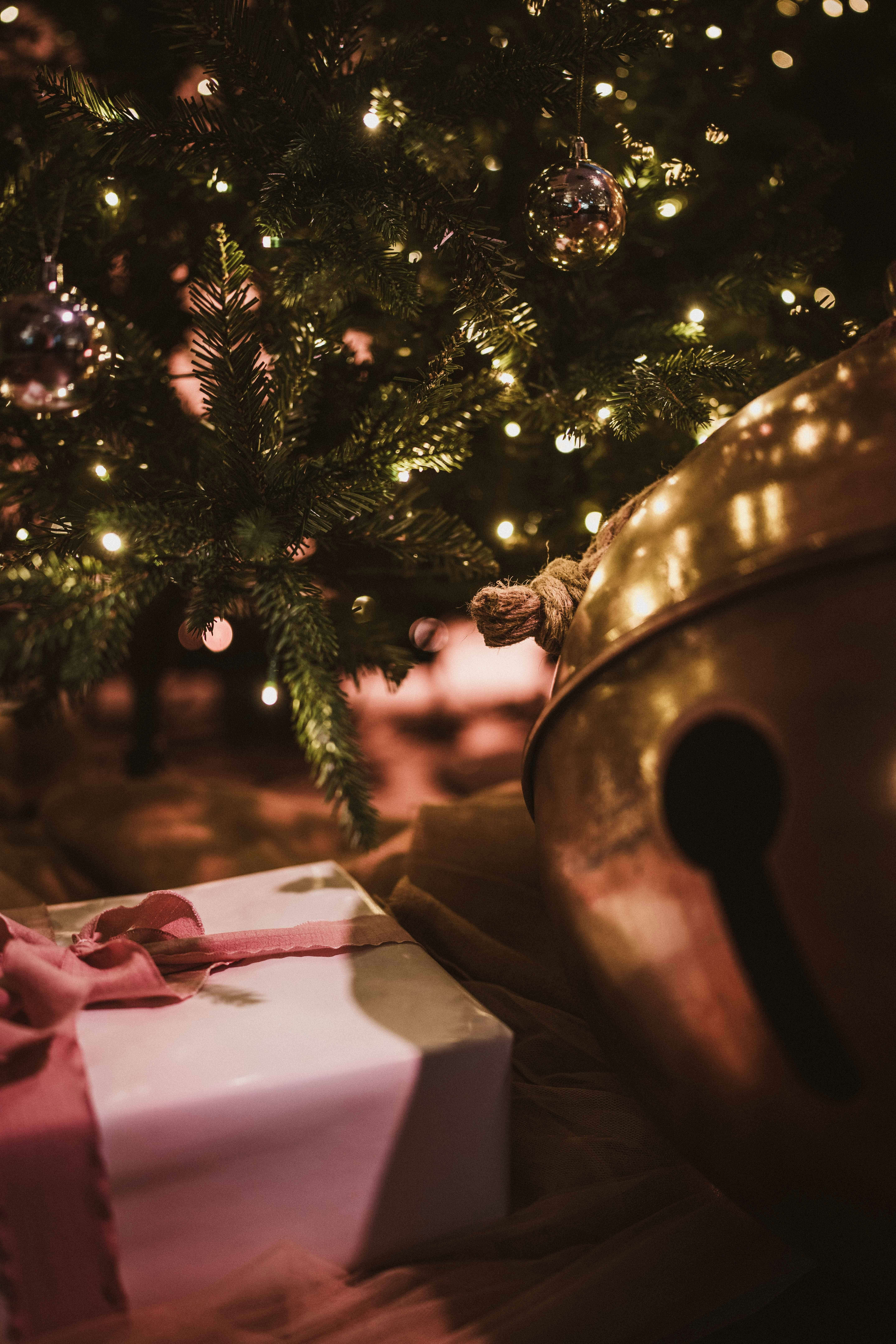 Christmas tree with presents and a large golden bell. photo – Free ...
